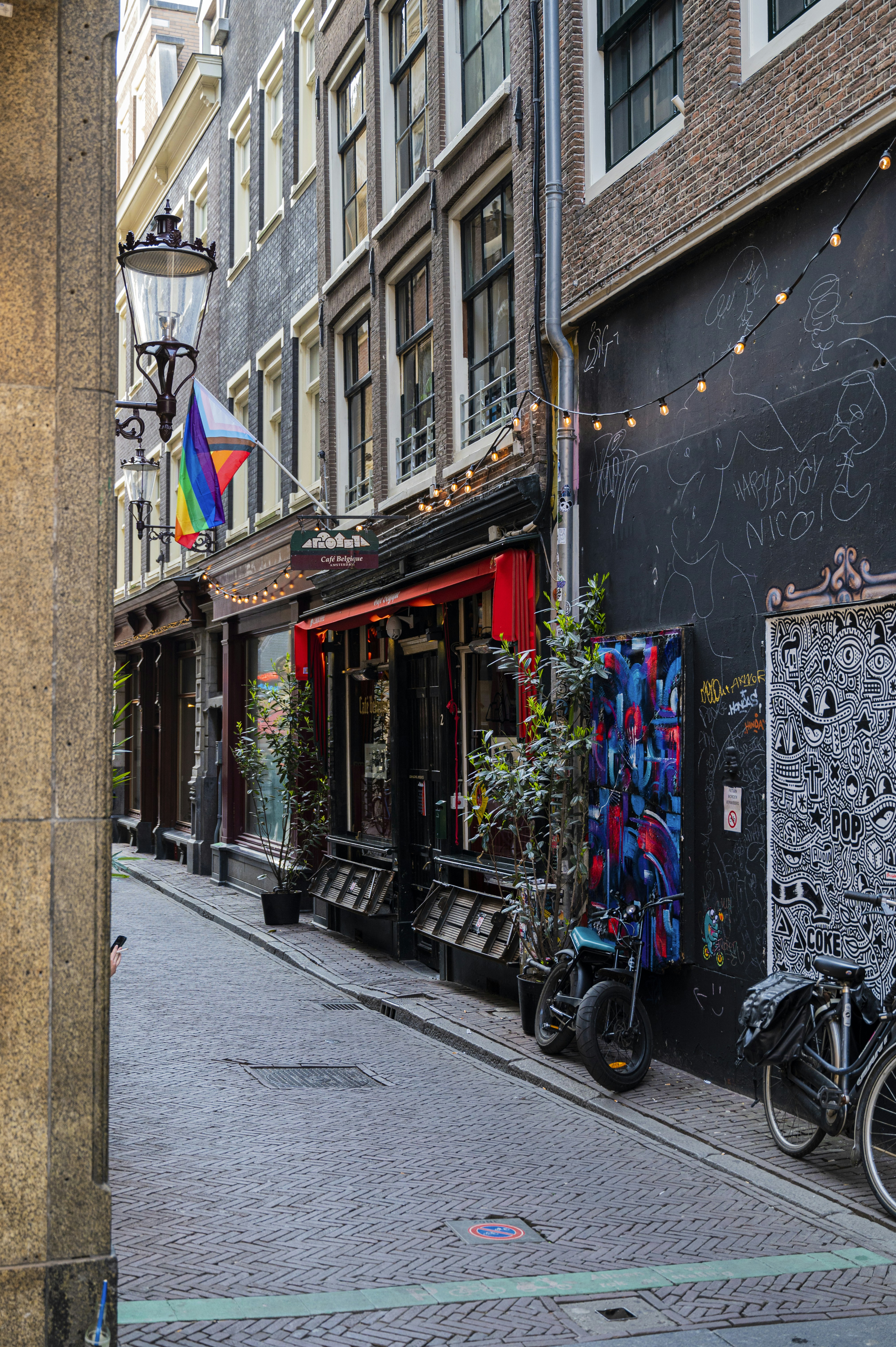 Rainbow Flag Alley: Brick Facades, Graffiti, and Warm String-Lights