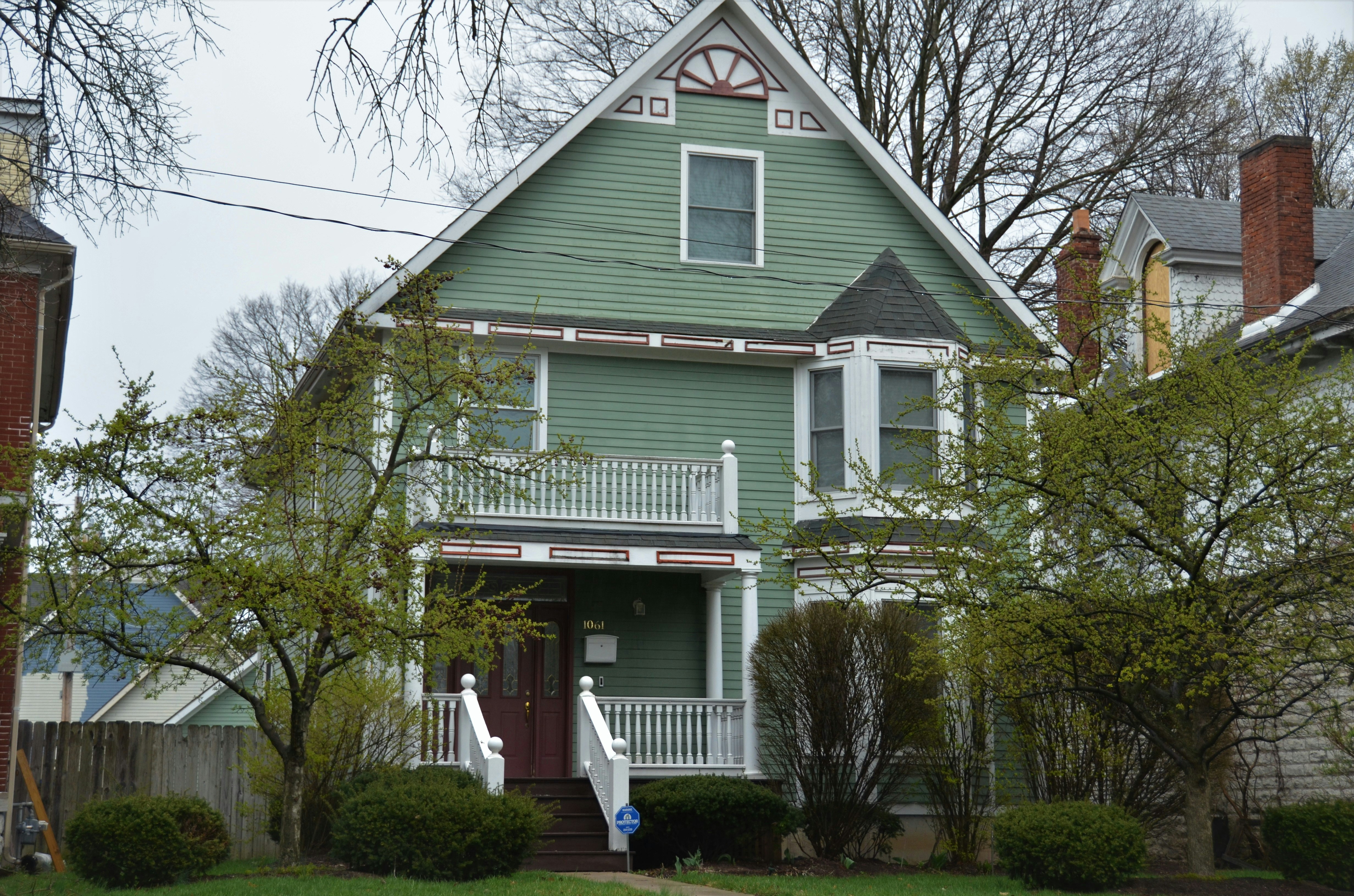 A green two story house with a white porch photo – Free Grey Image on ...