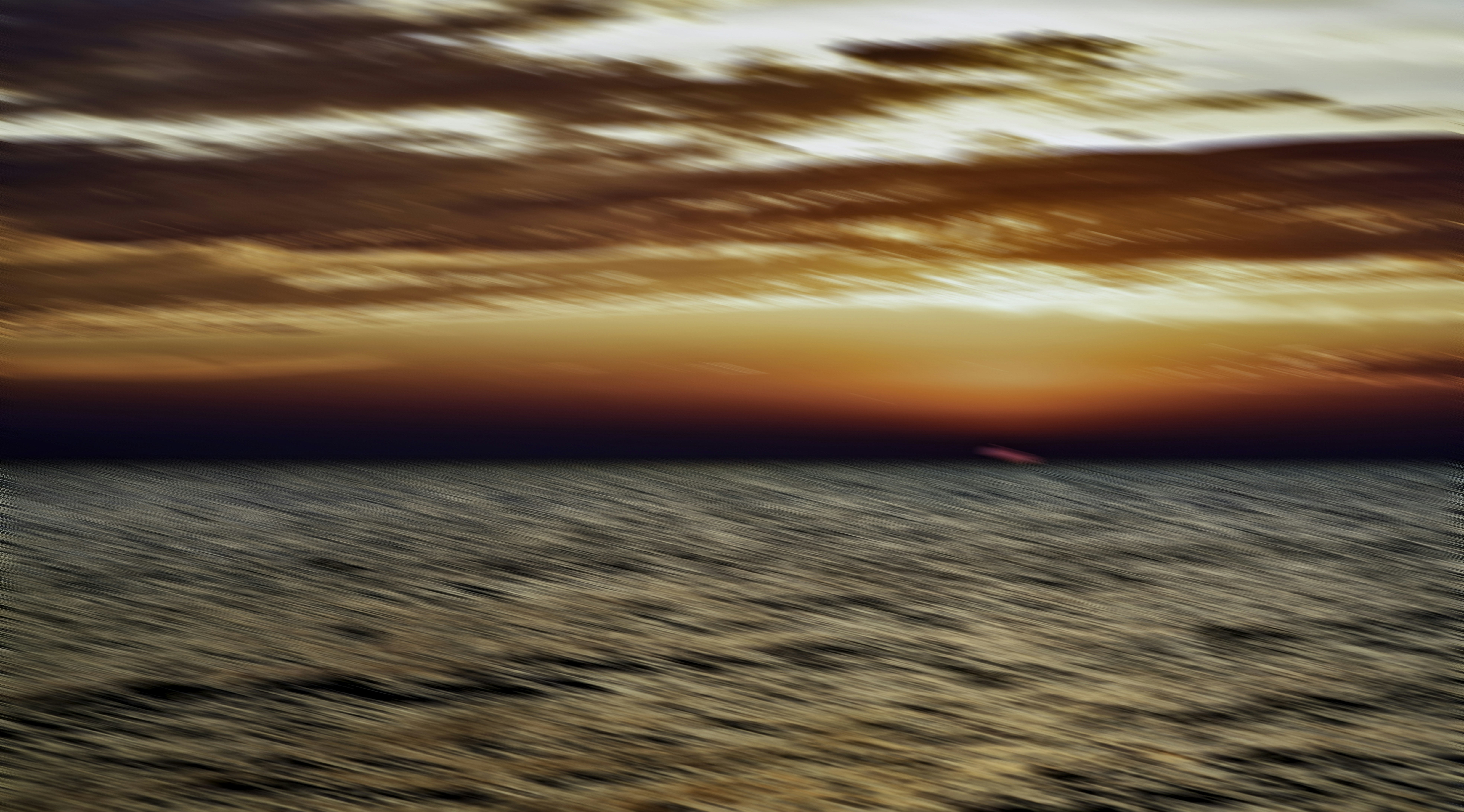 Horizon in Haze: A Blur of Sunset Over a Quiet Sea