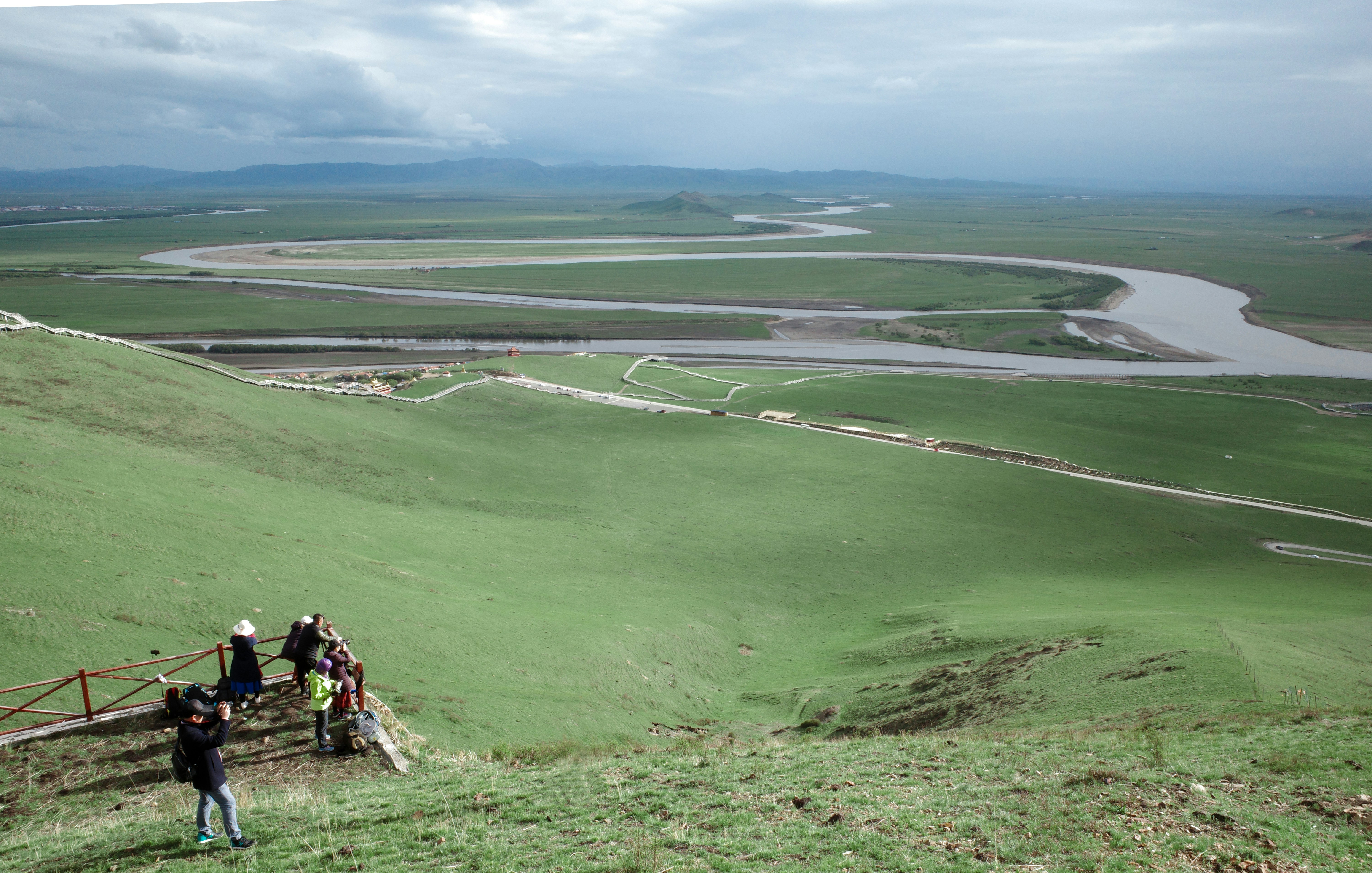 Emerald Ridge Overlook: Hikers at the Edge of a Winding River