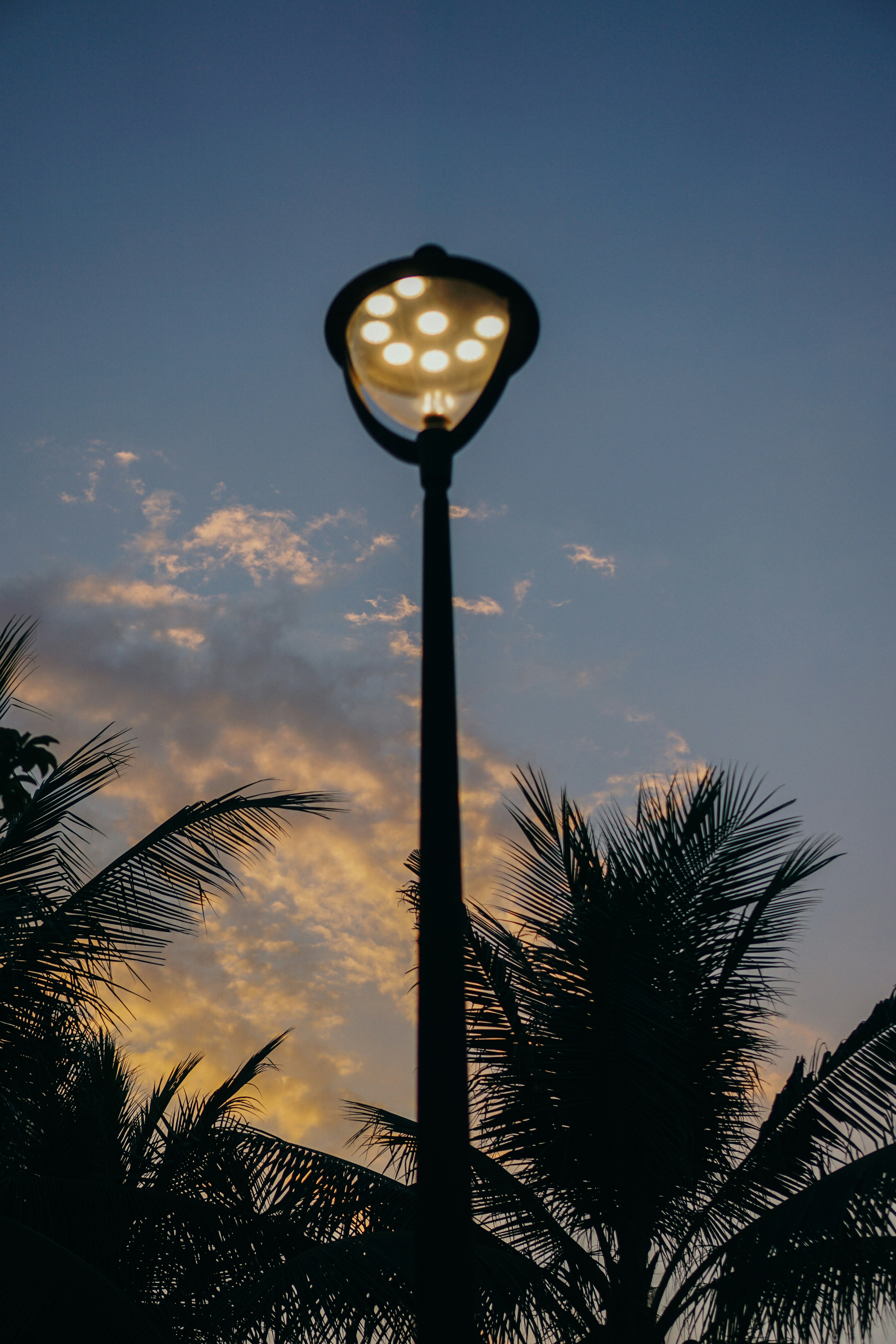 a street light with a sky in the background