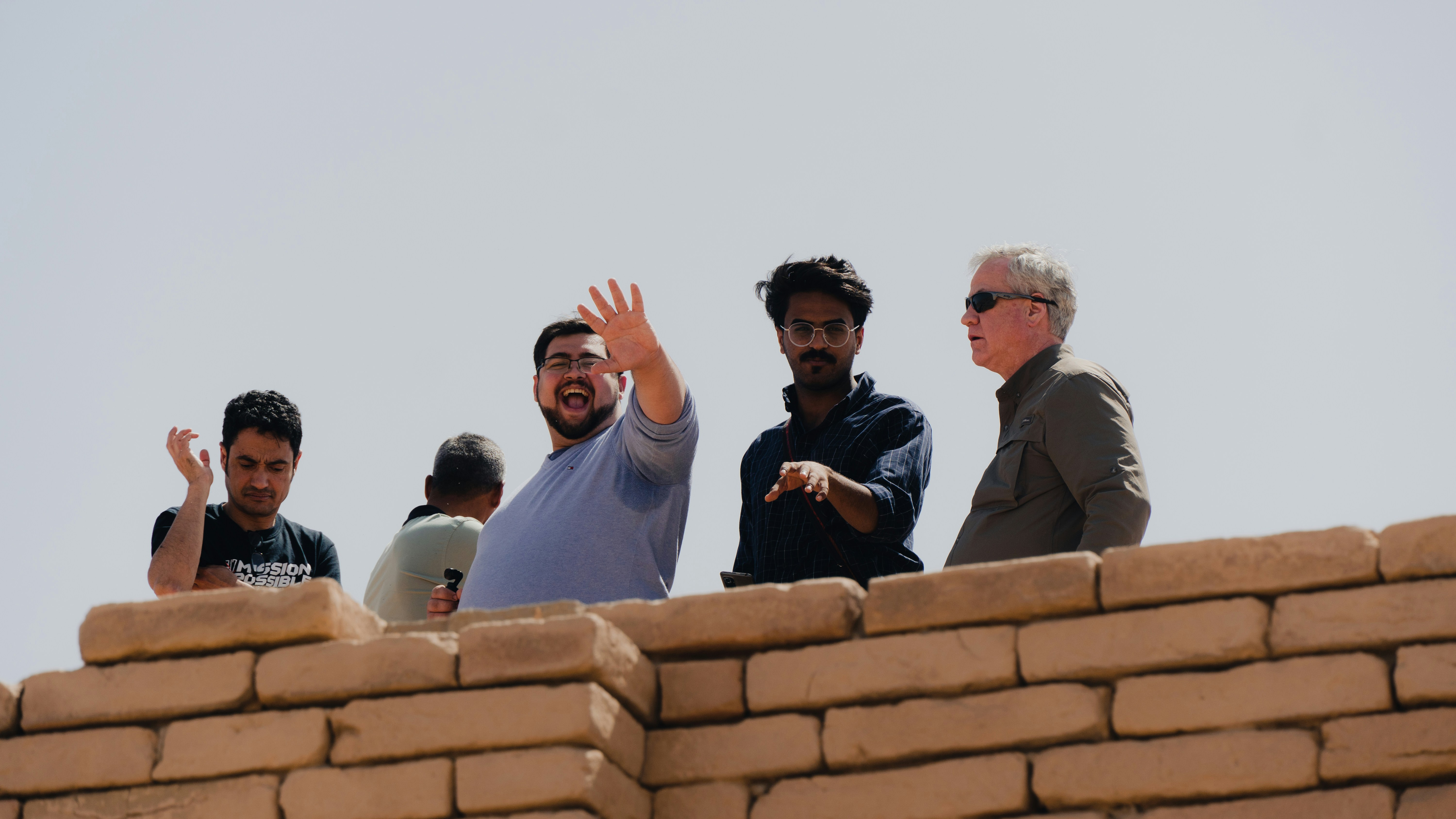 Wave hello from the rooftop: a candid moment above sunlit bricks