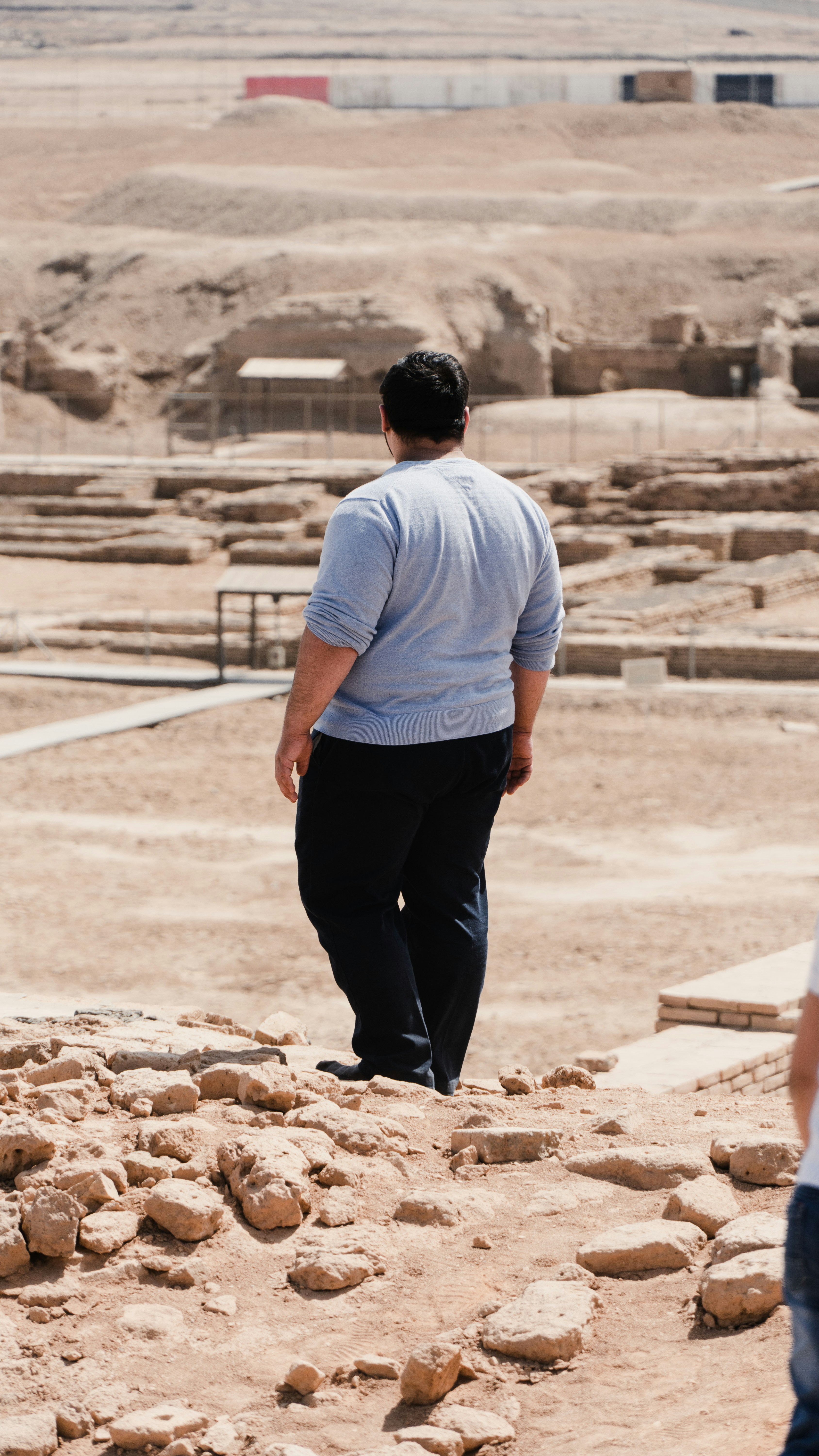 Backlit Explorer at an Ancient Excavation Site