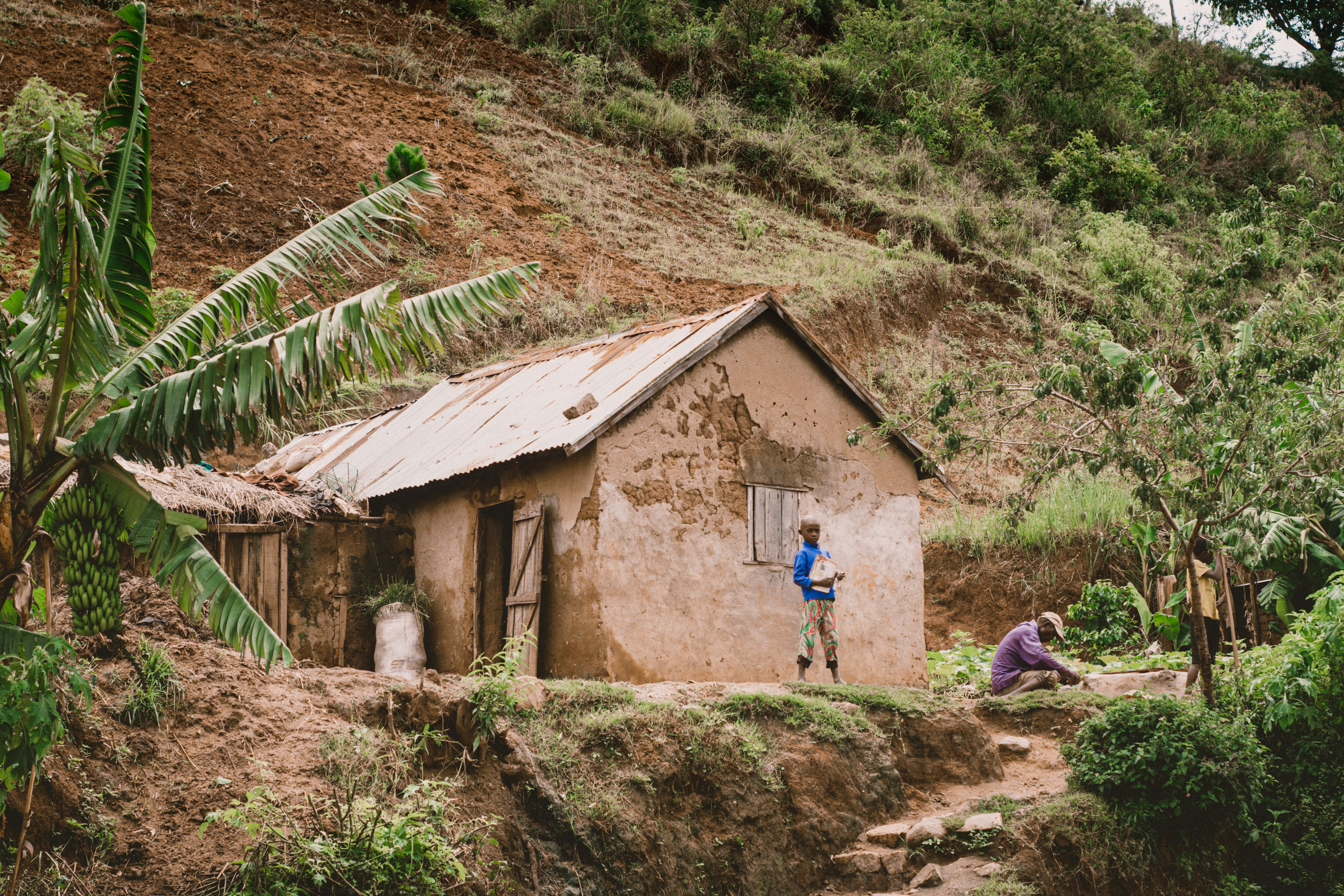 Two people standing outside of a small building photo – Free Building ...