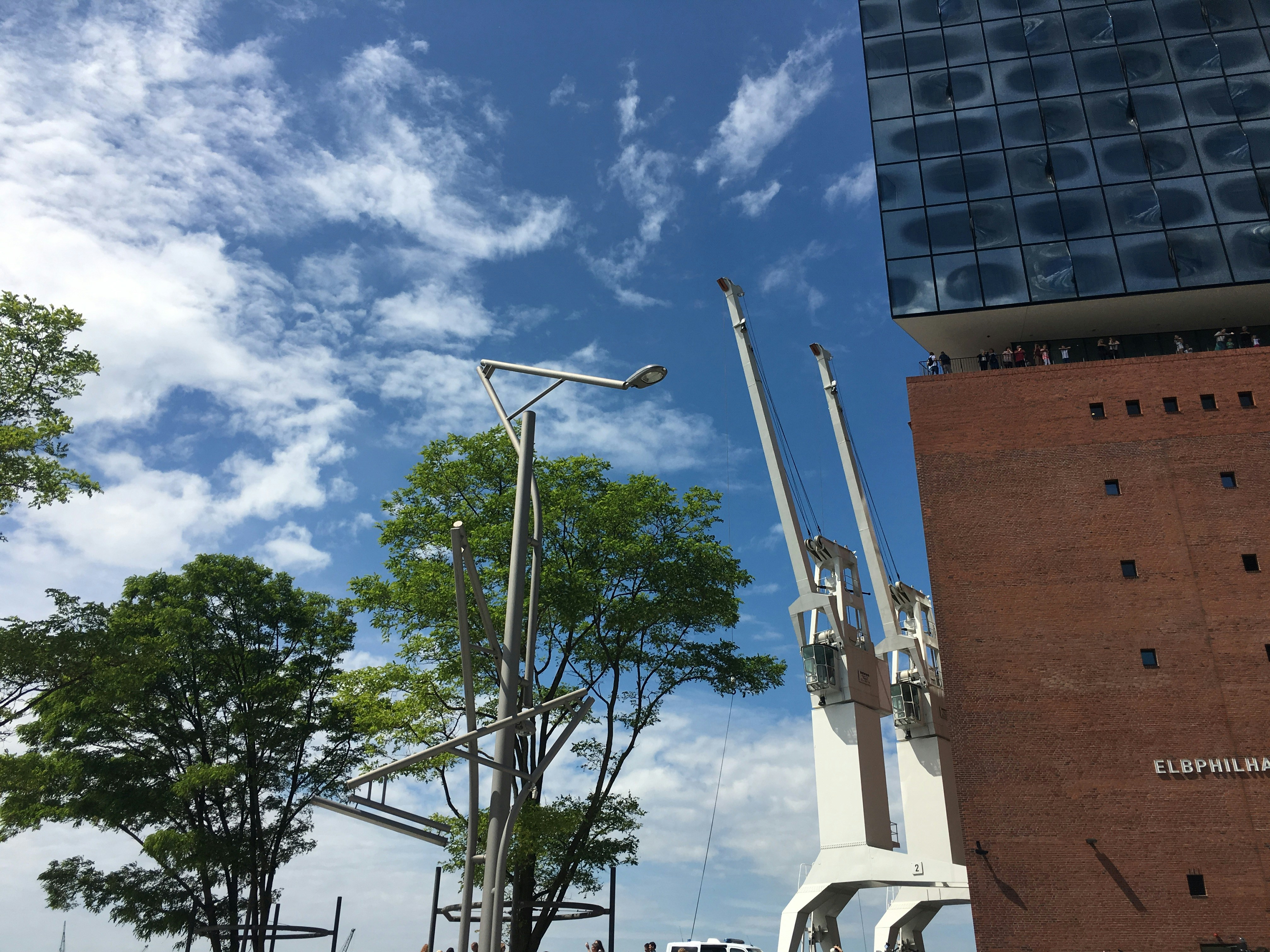A street light next to a tall building photo – Free Hafencity Image on ...