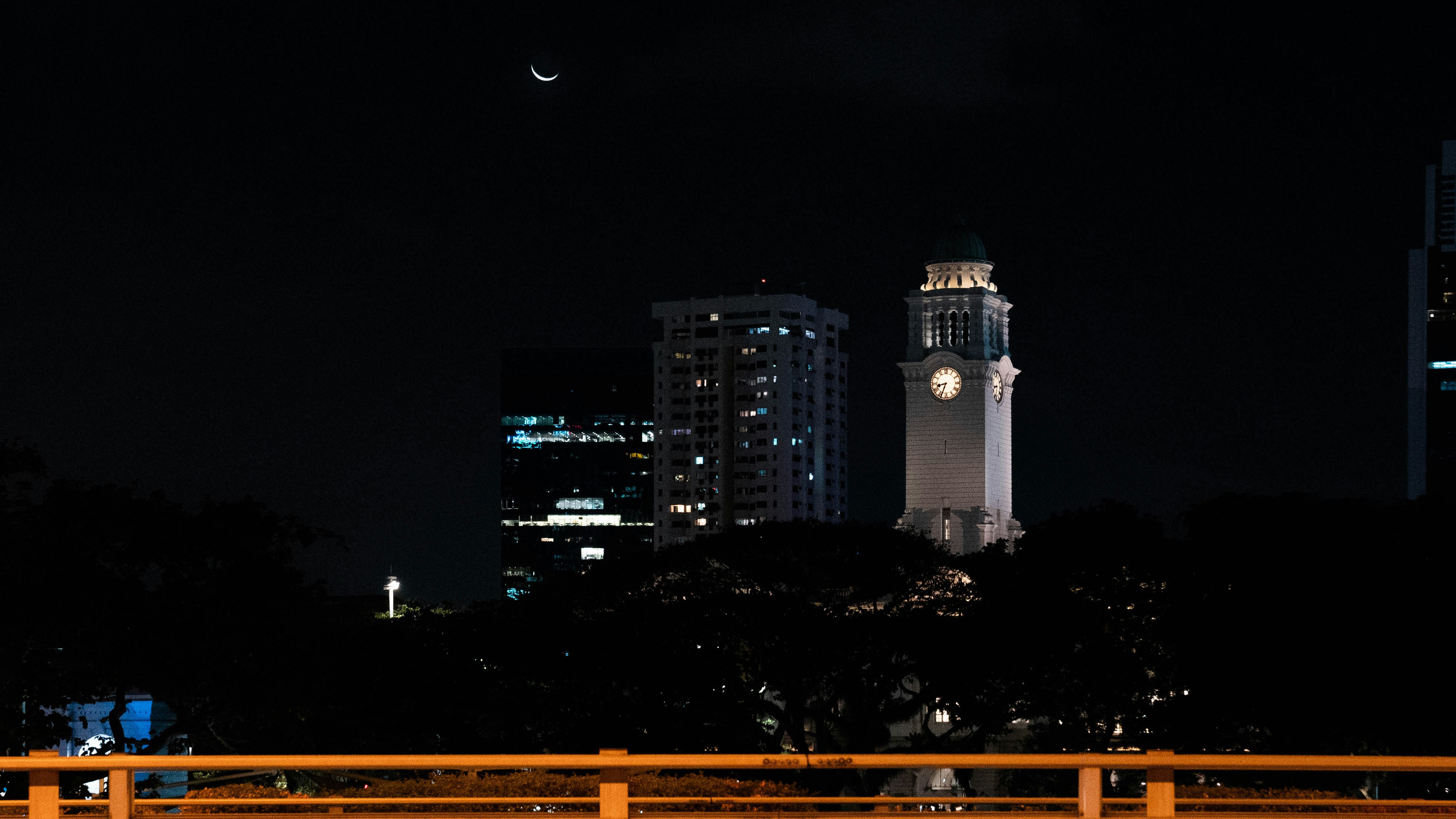 Moonlit Clock Tower Rising Over a Quiet Neon City Night