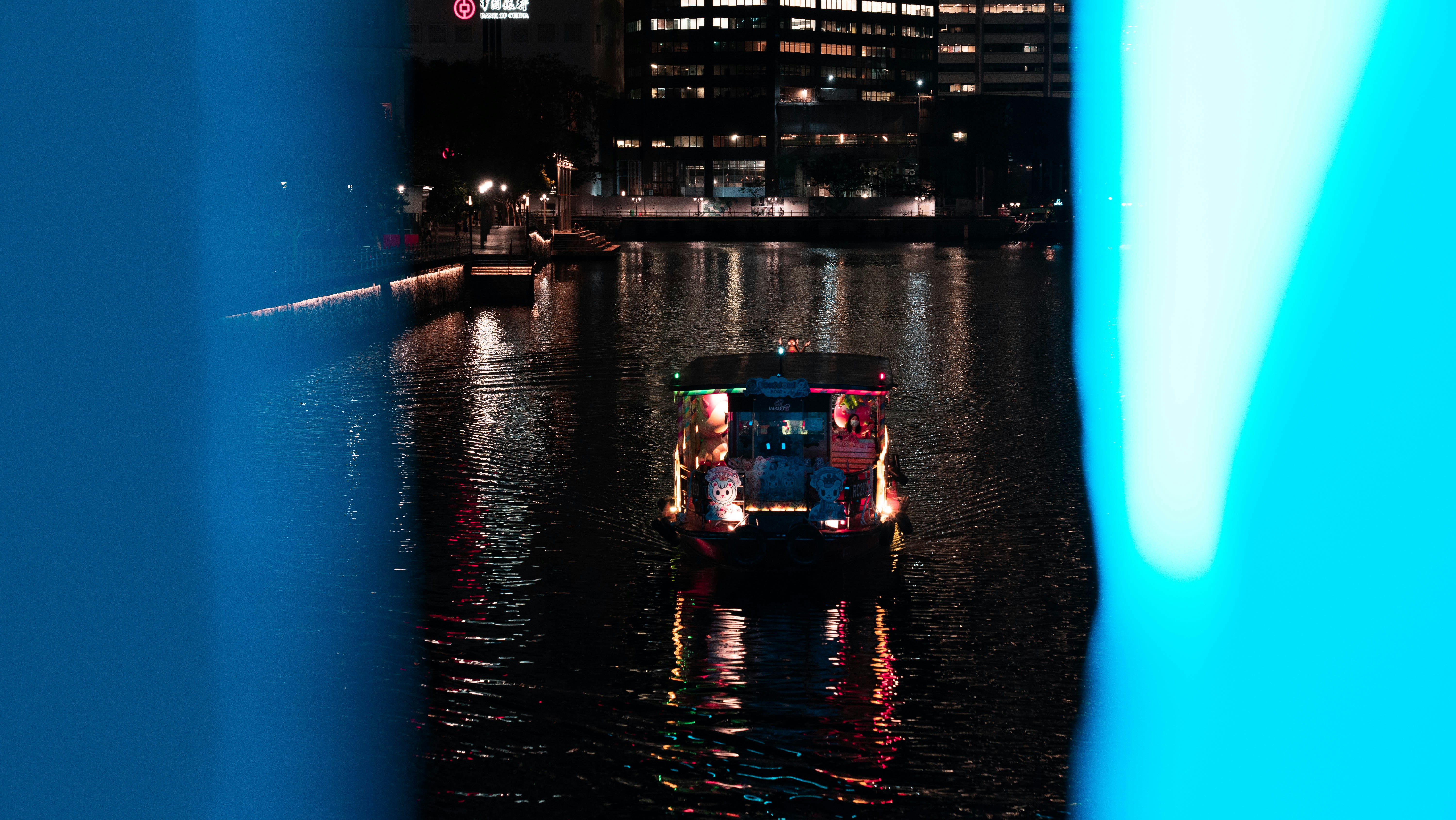 Under Neon Arches: A Night Boat on Velvet Water