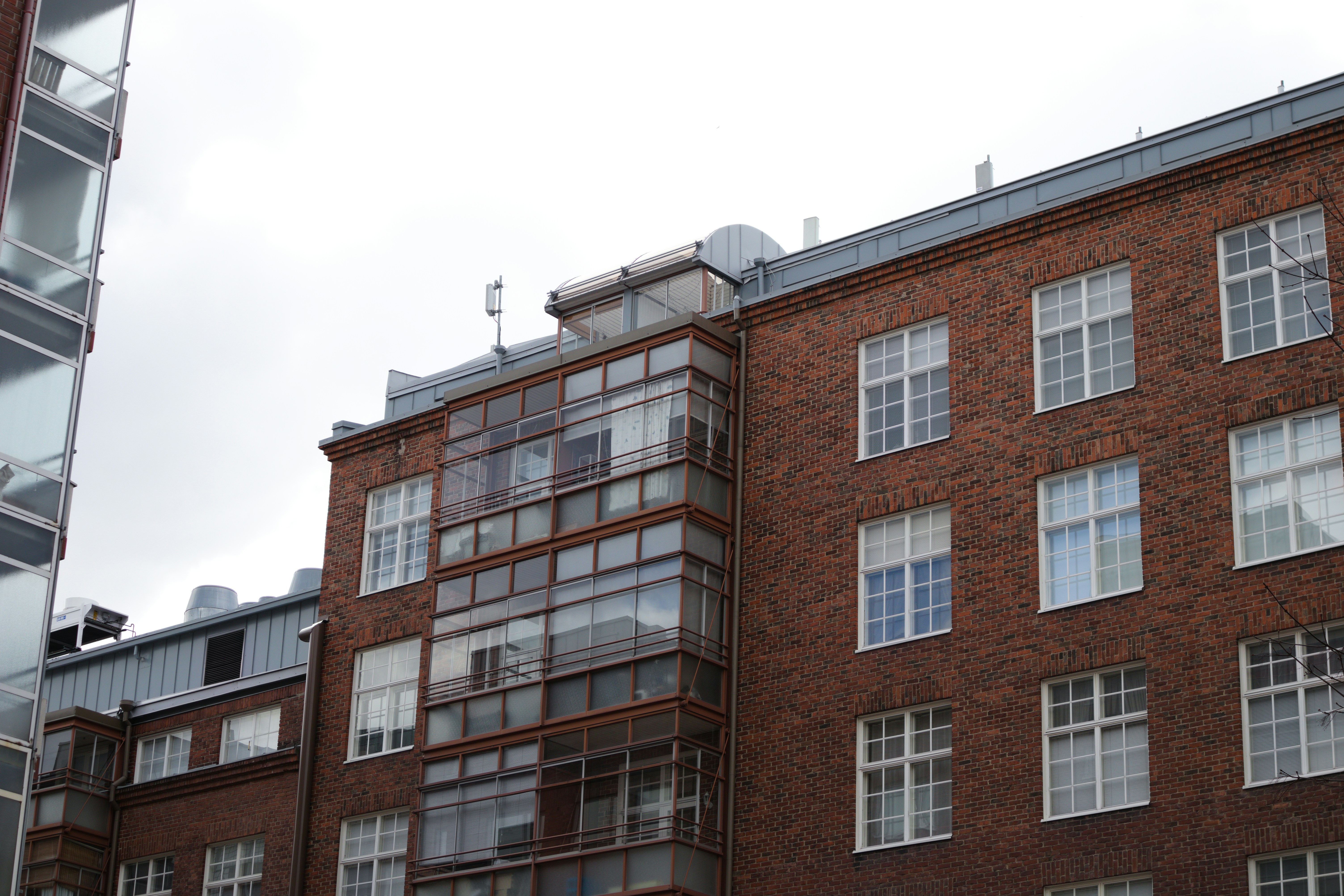 A tall red brick building with lots of windows photo – Free Turku Image ...