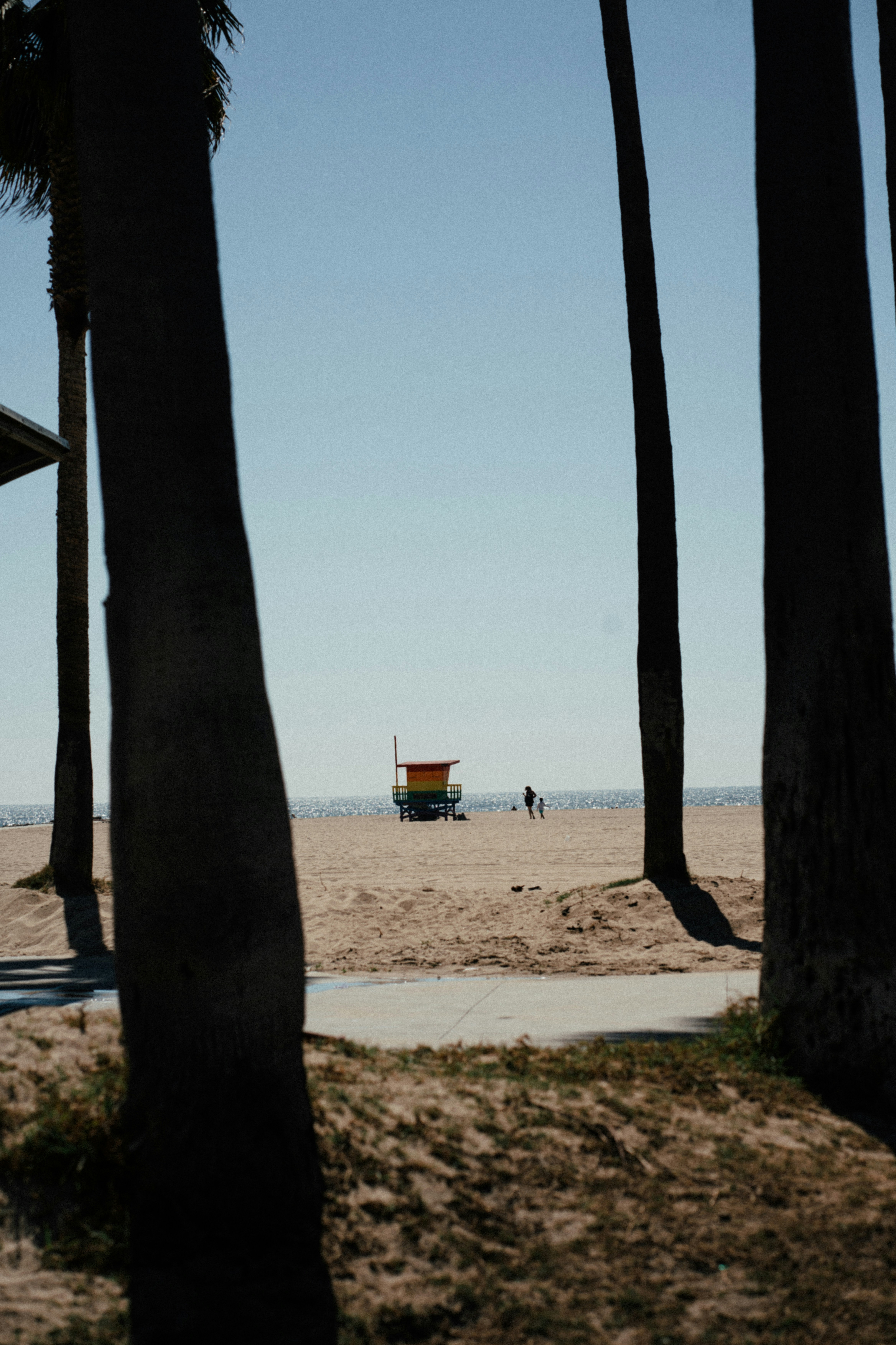 Lifeguard Chair at Distant Horizon Framed by Coastal Arches