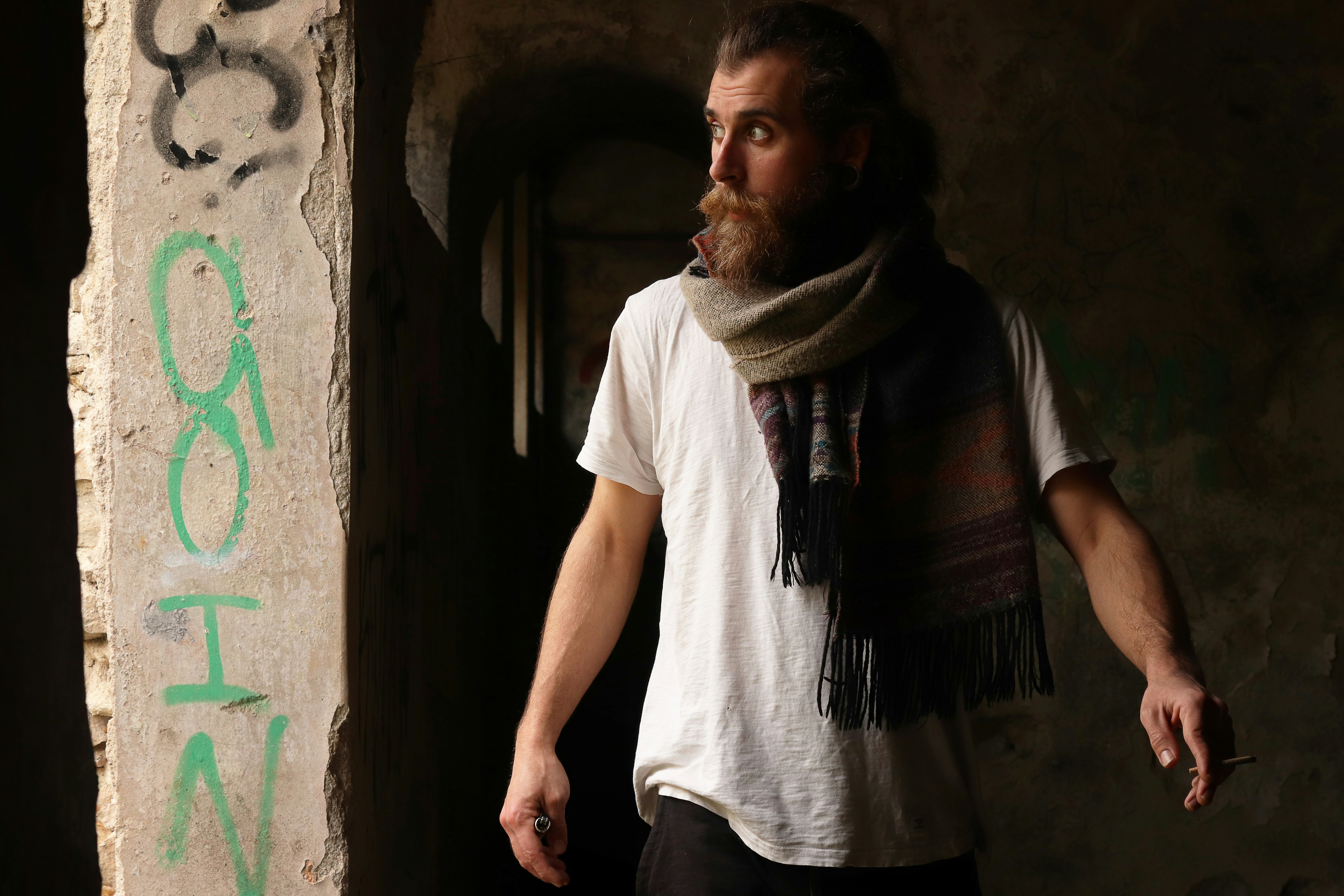 Edge of Light: Bearded Stranger in a Graffiti-Softened Corridor