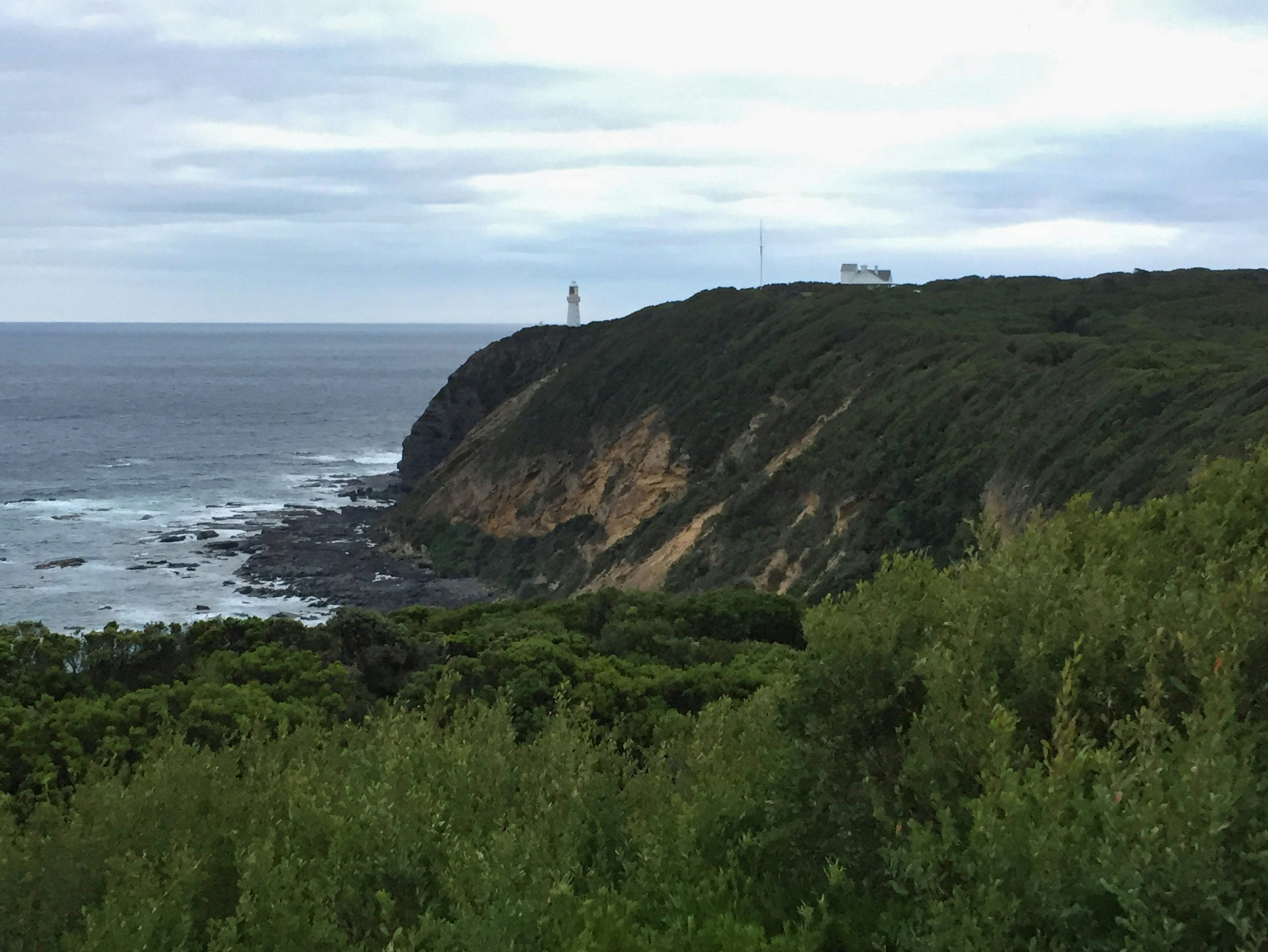 Sea Cliff Sentinel: A Lighthouse Oversees the Distant Horizon