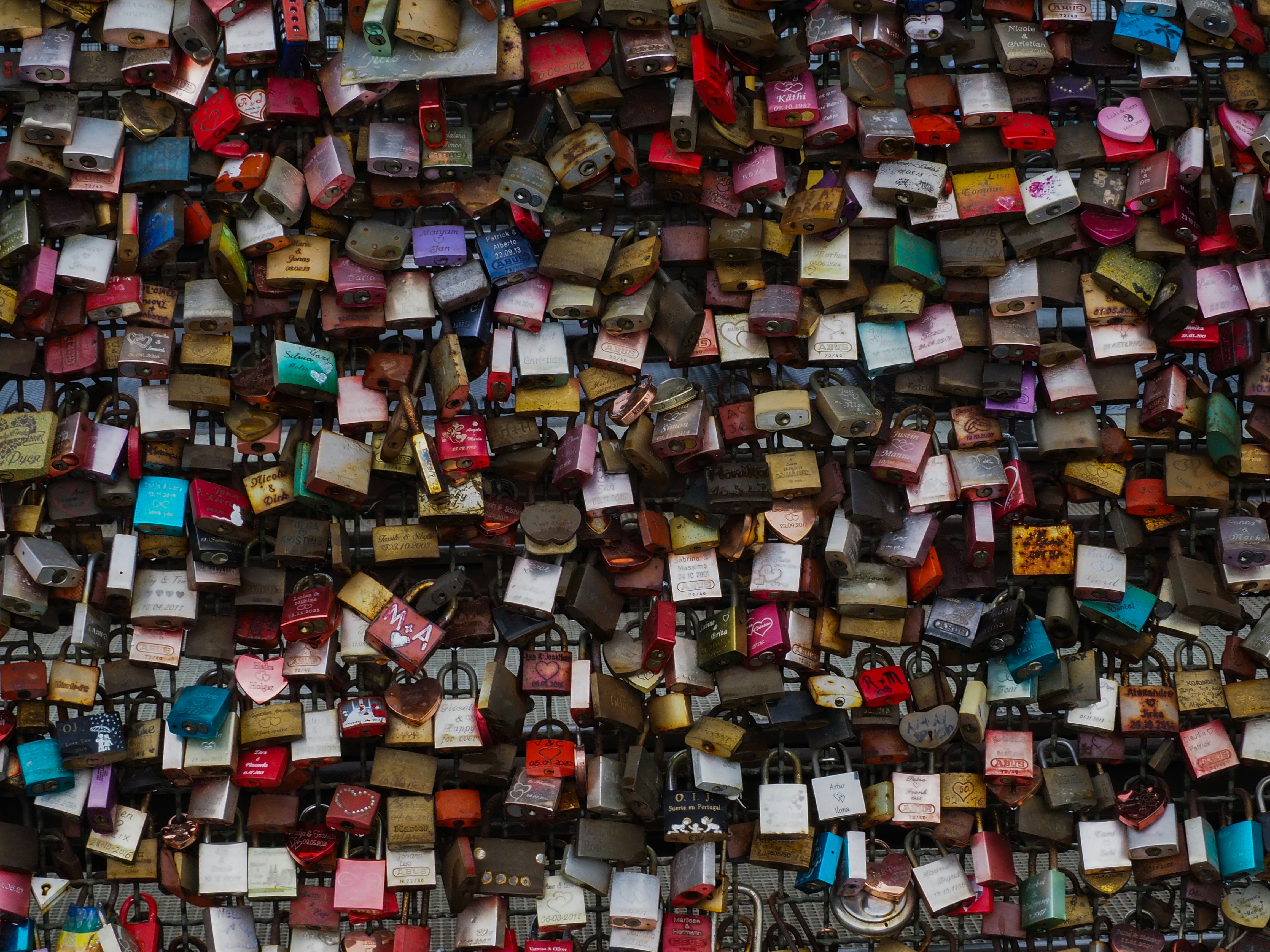 A wall covered in lots of padlocks and locks photo – Free Advertisement ...