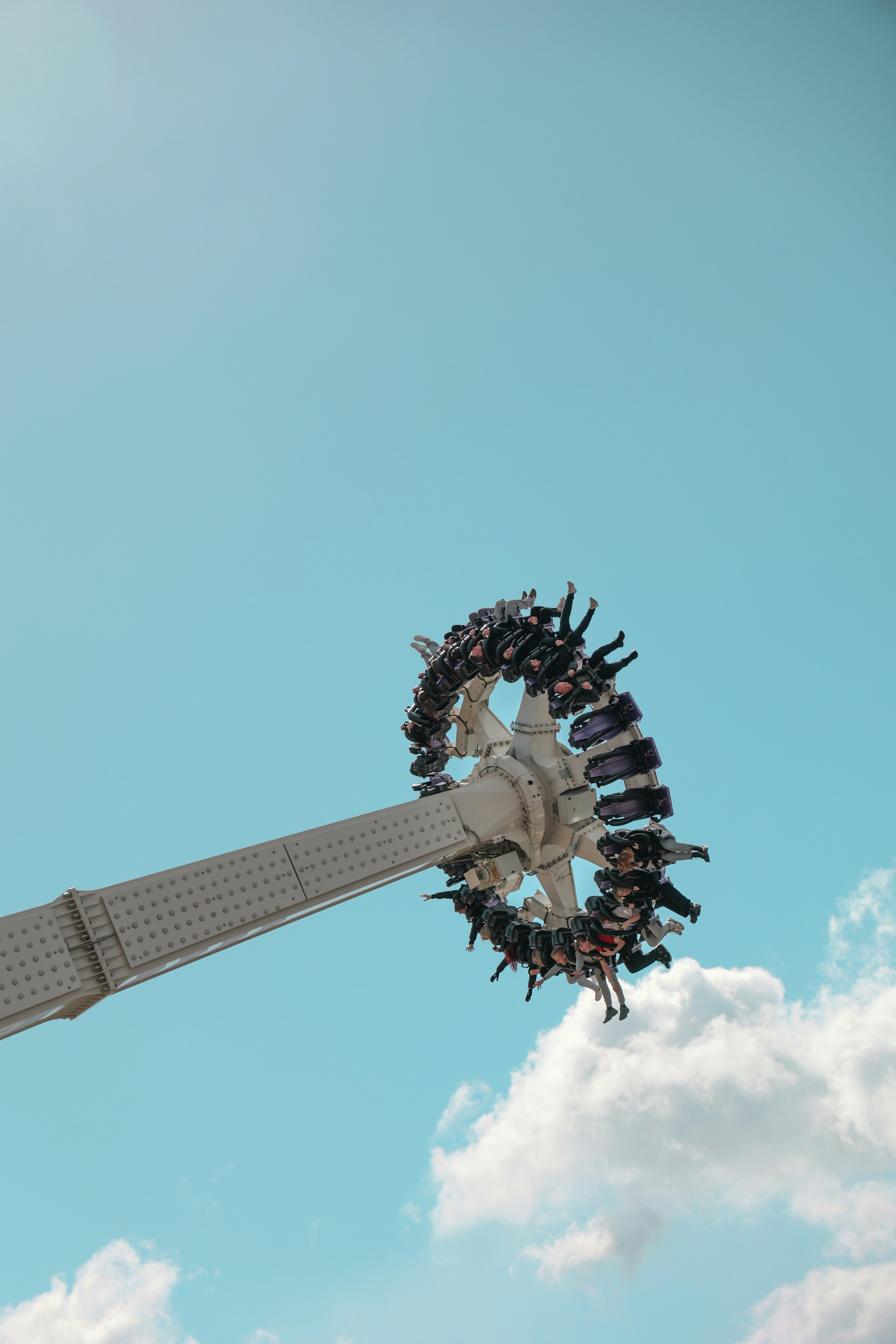 Ring of Flight: Riders Swing Around a Tilted Carousel Against a Cerulean Sky