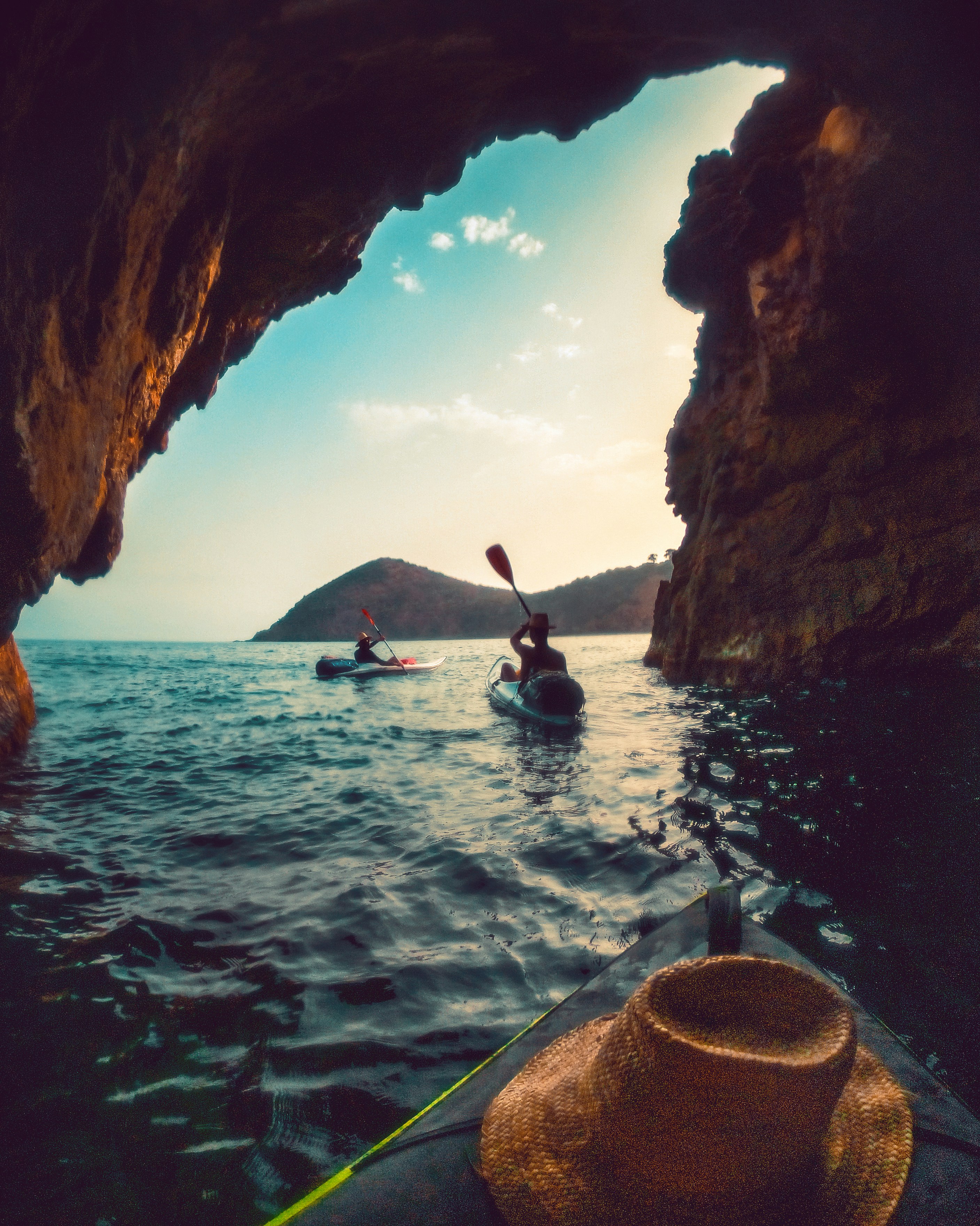 Cavernous Passage: Kayakers Glide Through a Sea-Arch