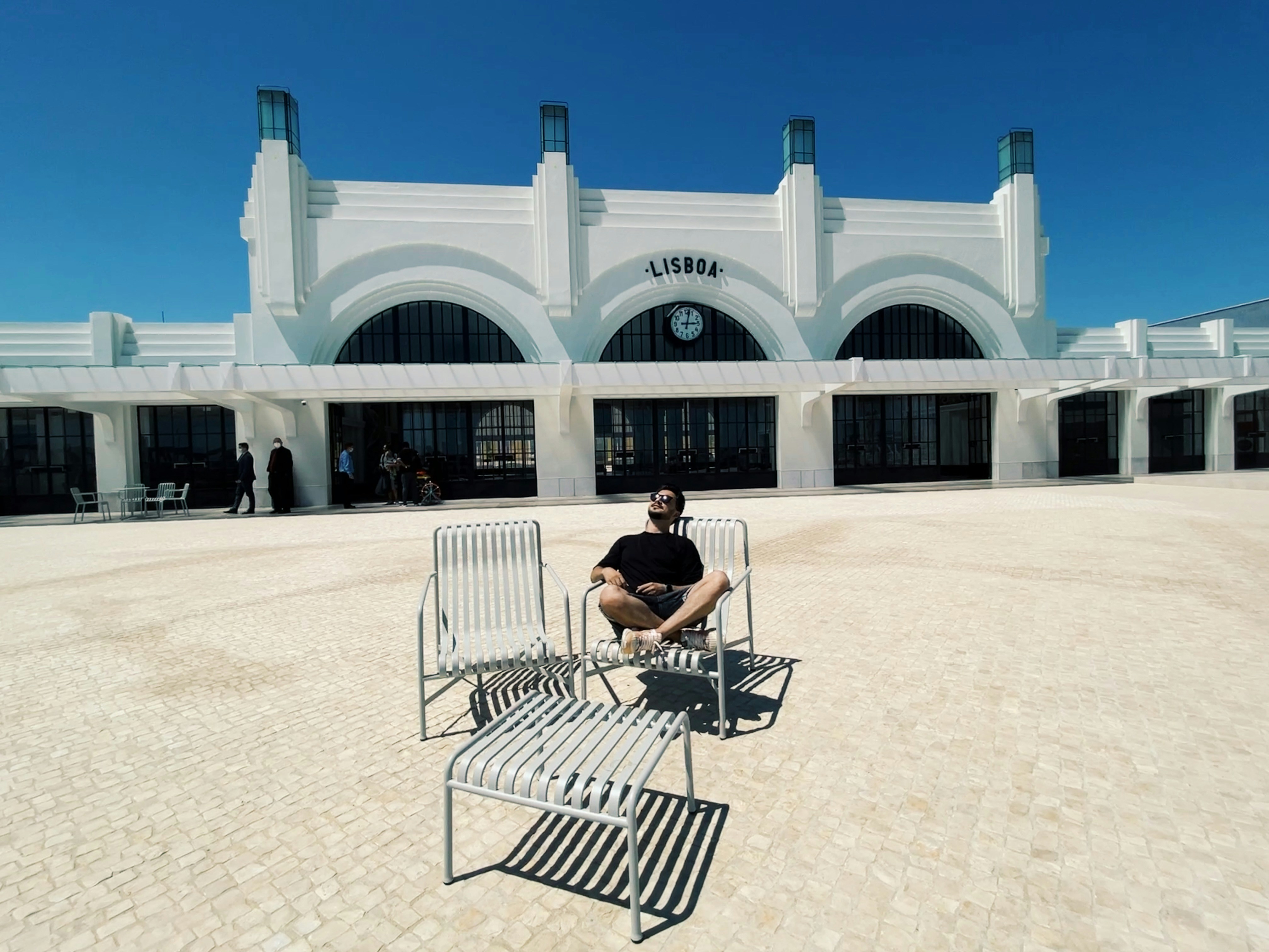 Sunlit Pause Before Lisboa's White Arcades