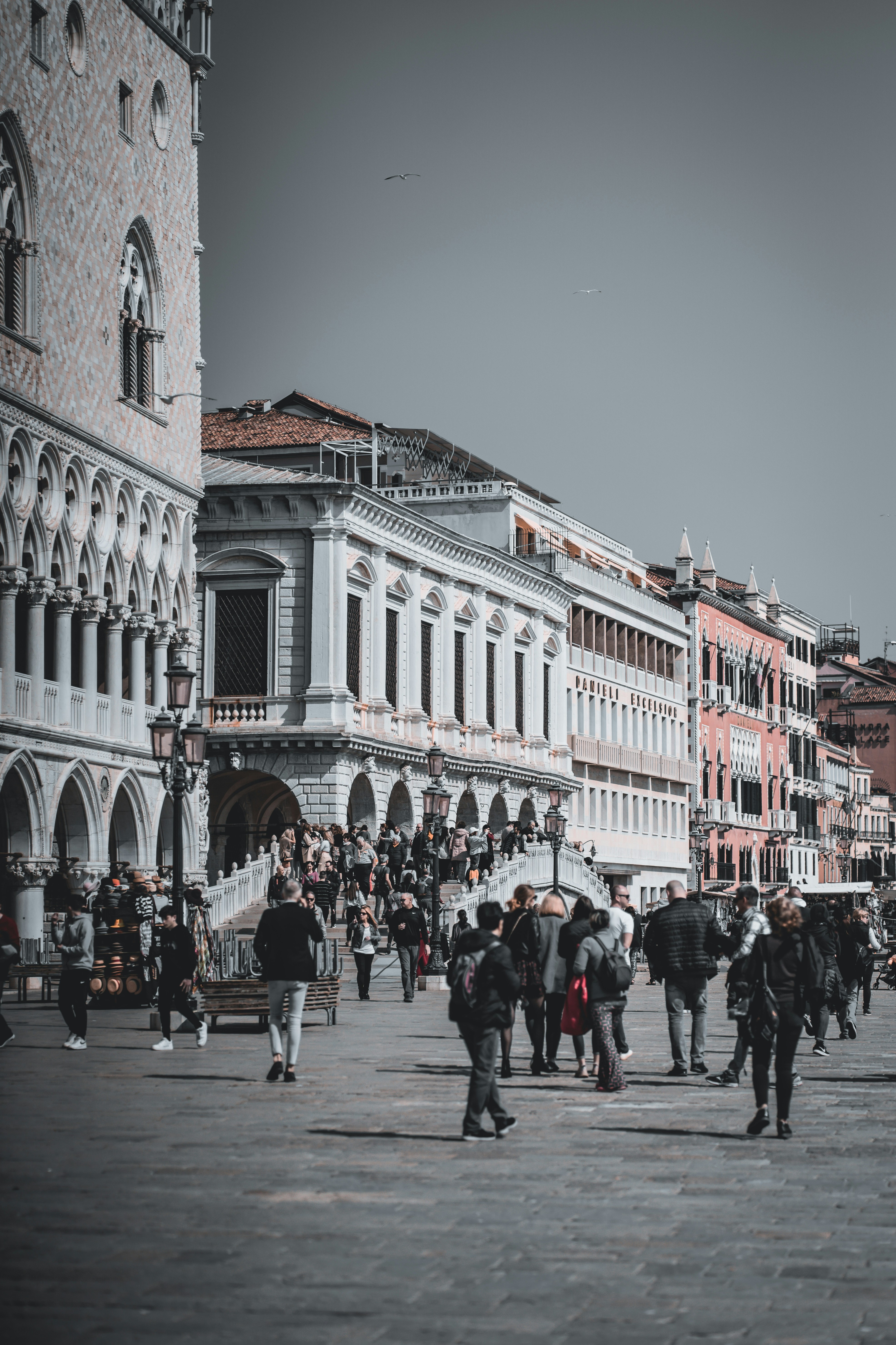 Arcaded Venice: A Crowded Promenade Beneath Timeworn Facades