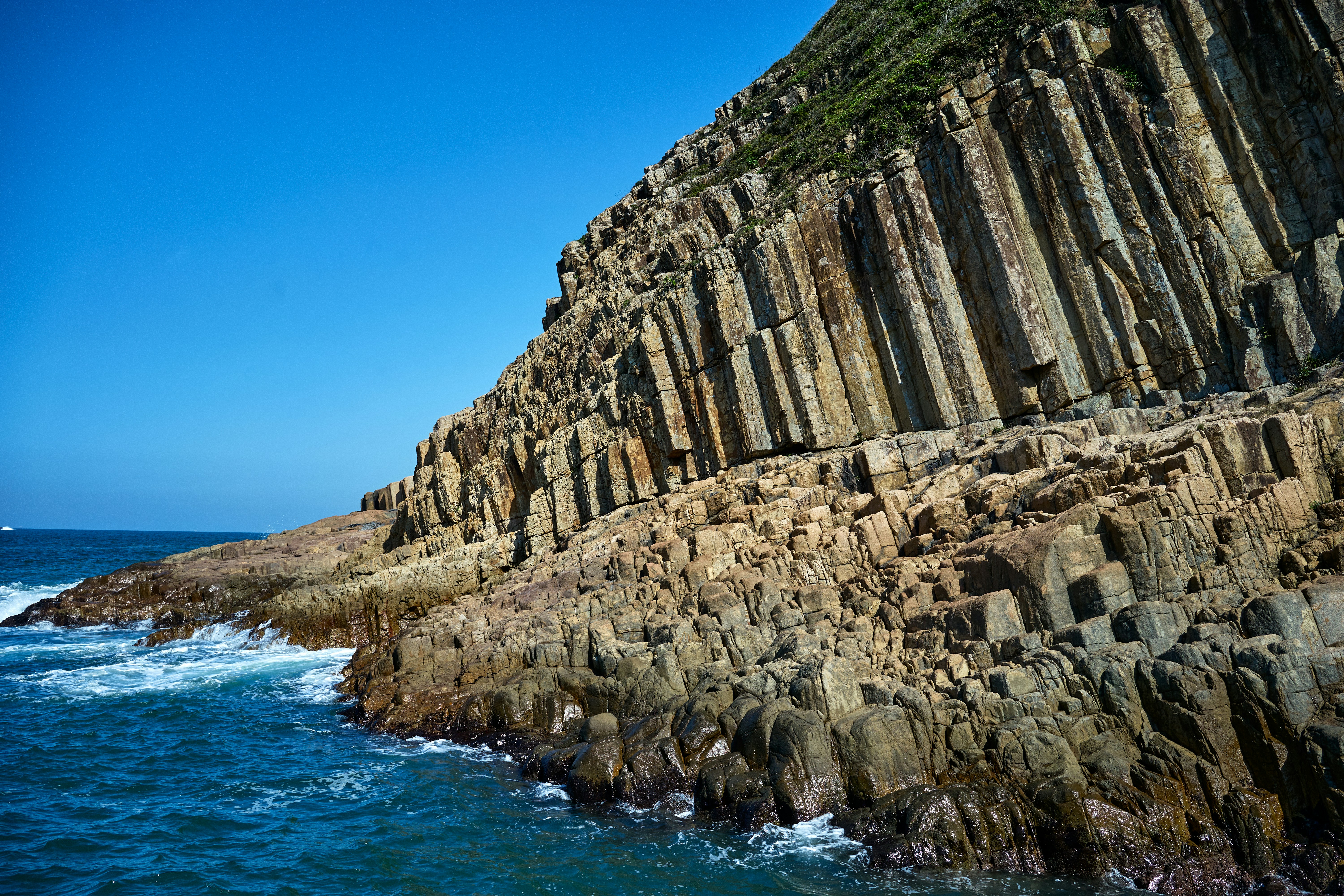 A large rock formation next to a body of water photo – Free 破邊洲 hong ...