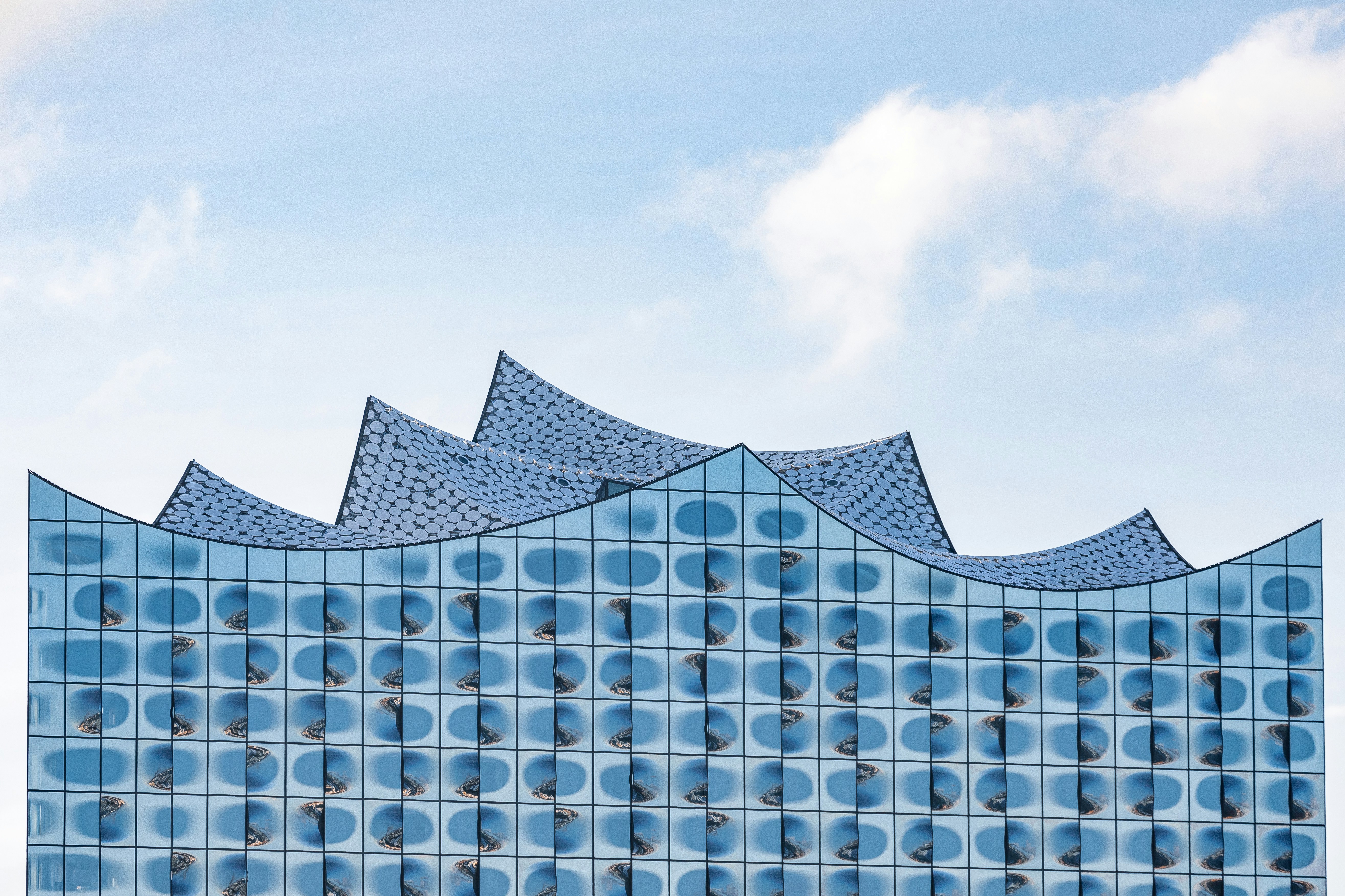 Wavy Glass Facade: A Ceremonial Edge of Blue orbs