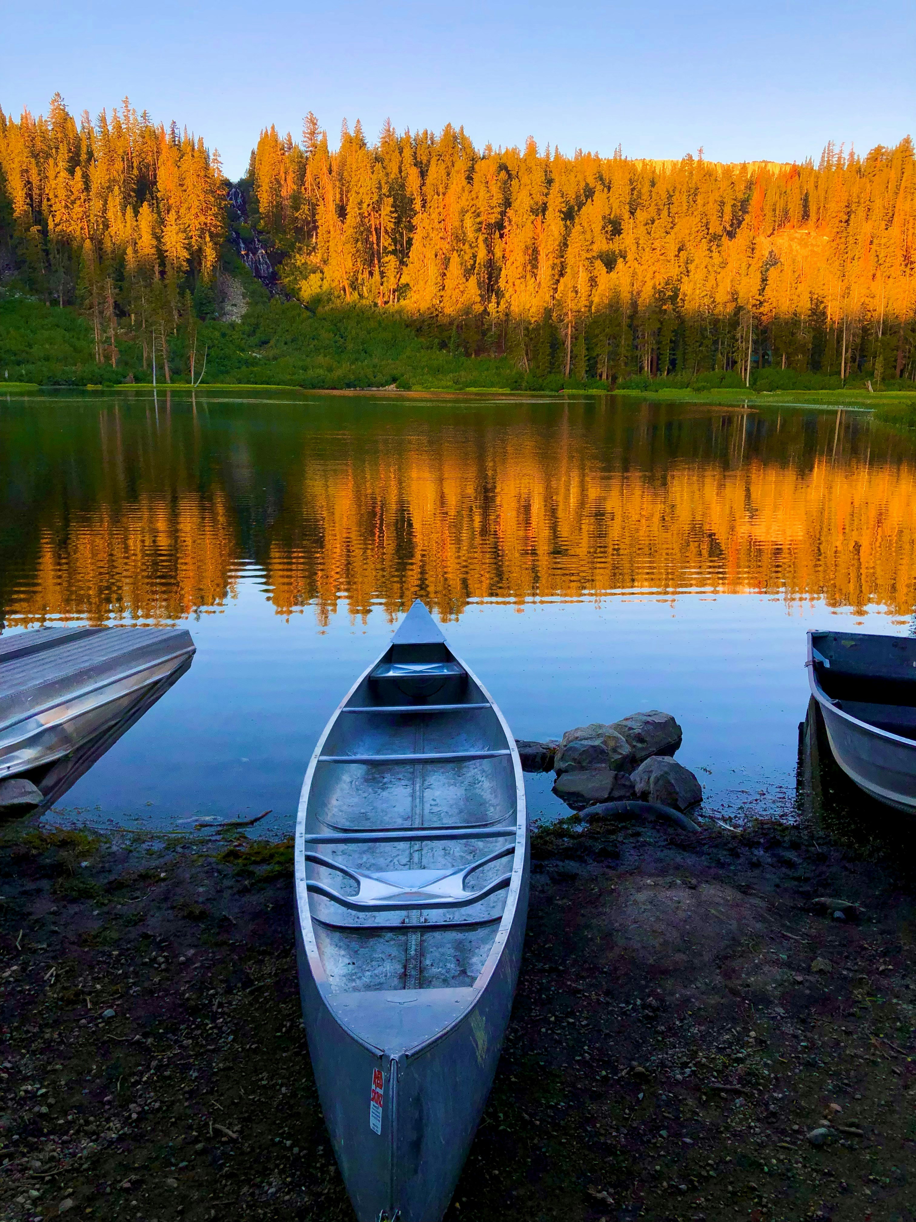 Two canoes sitting on the shore of a lake photo – Free Usa Image on ...