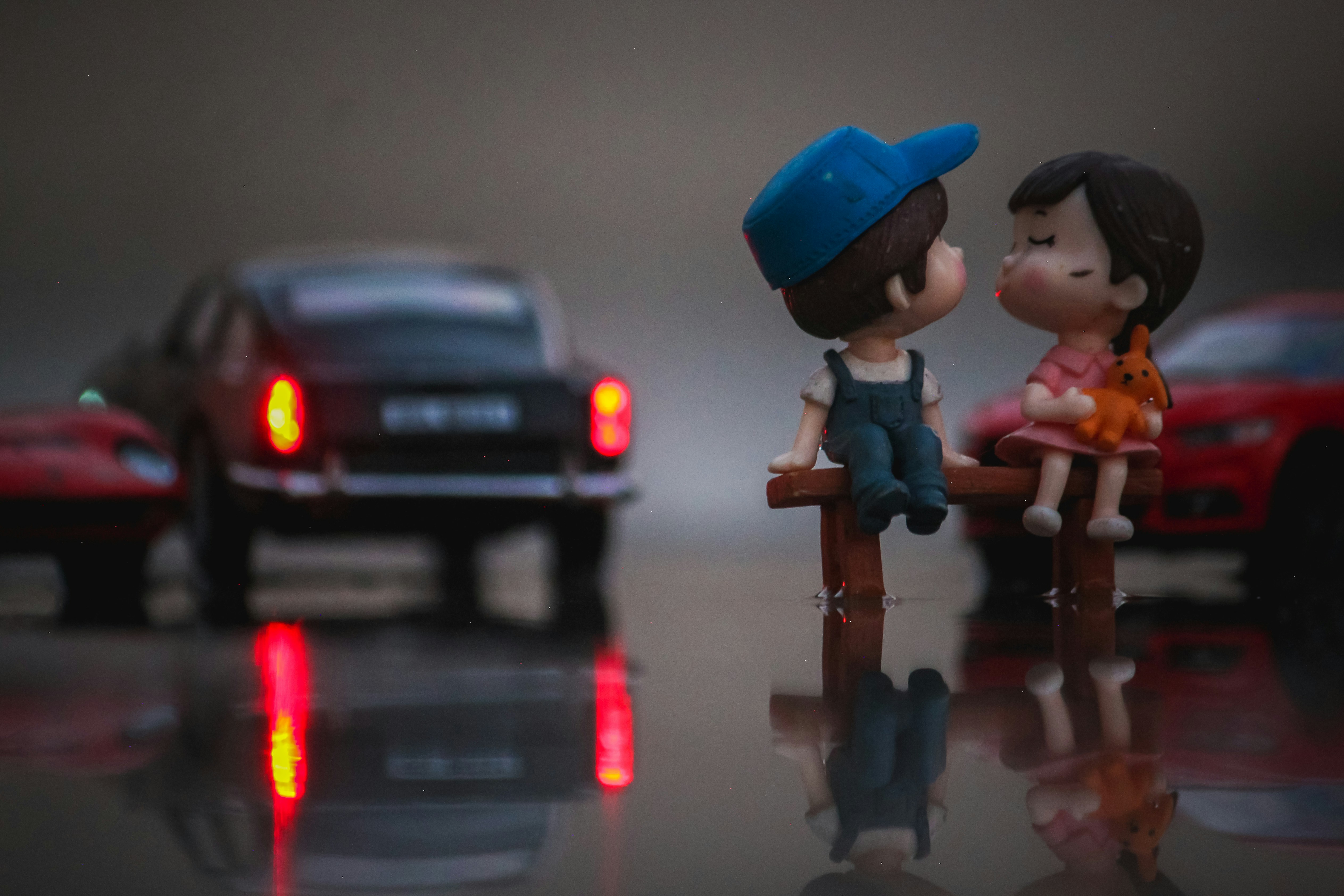 Two Toy Companions on a Rain-Washed Street