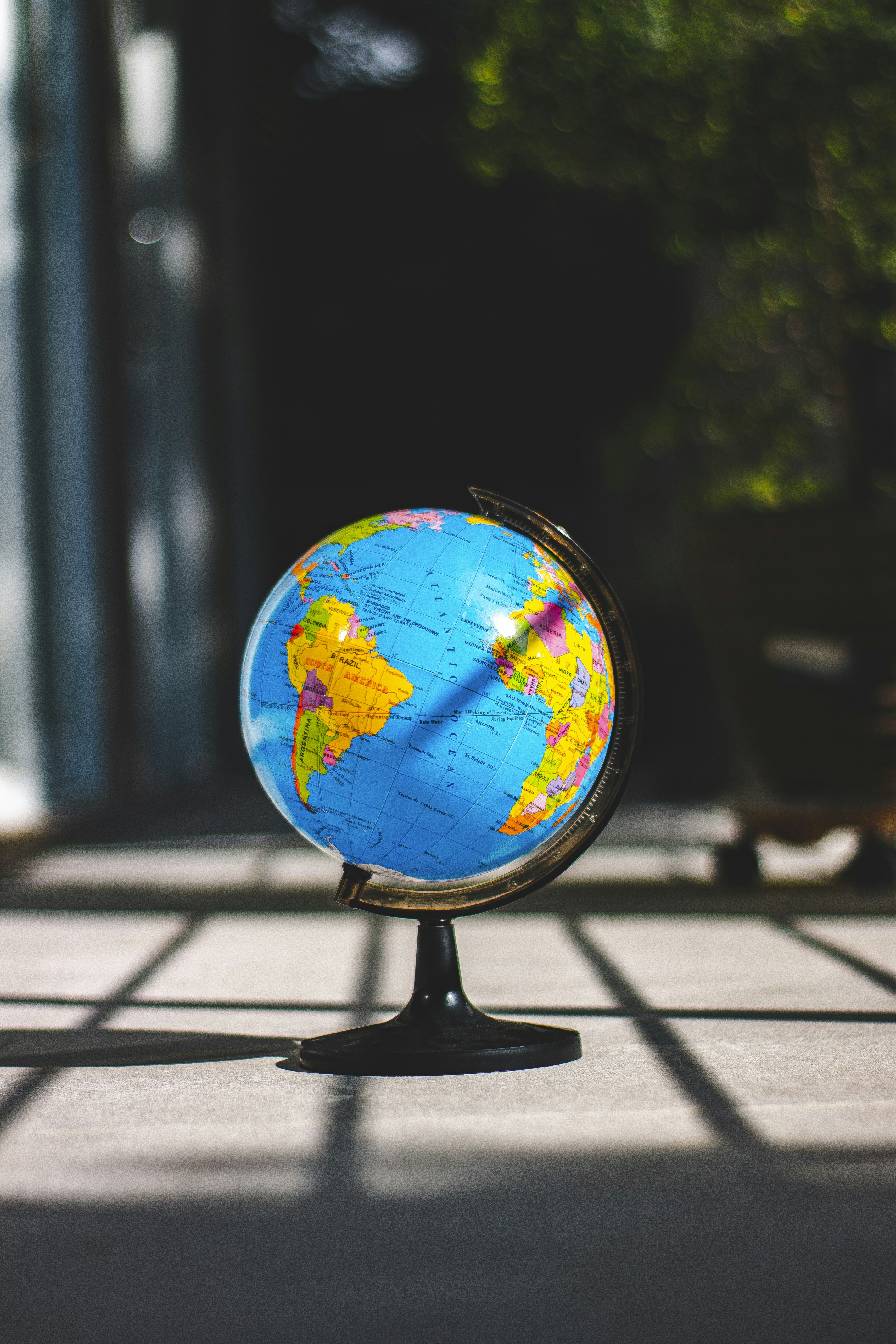 A blue and yellow globe sitting on top of a table photo – Free Planet ...