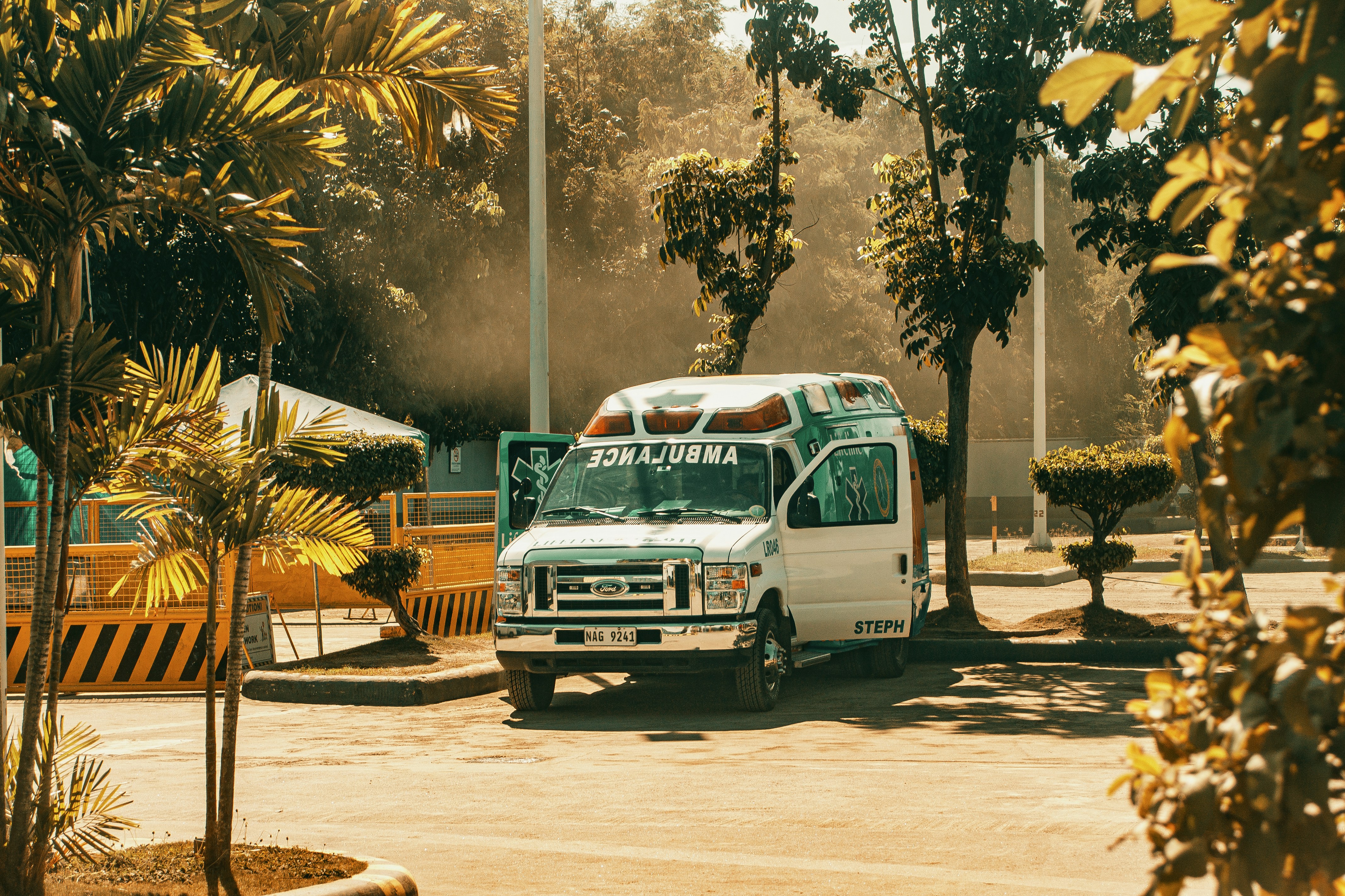Ambulance at a sunlit campus drop-off