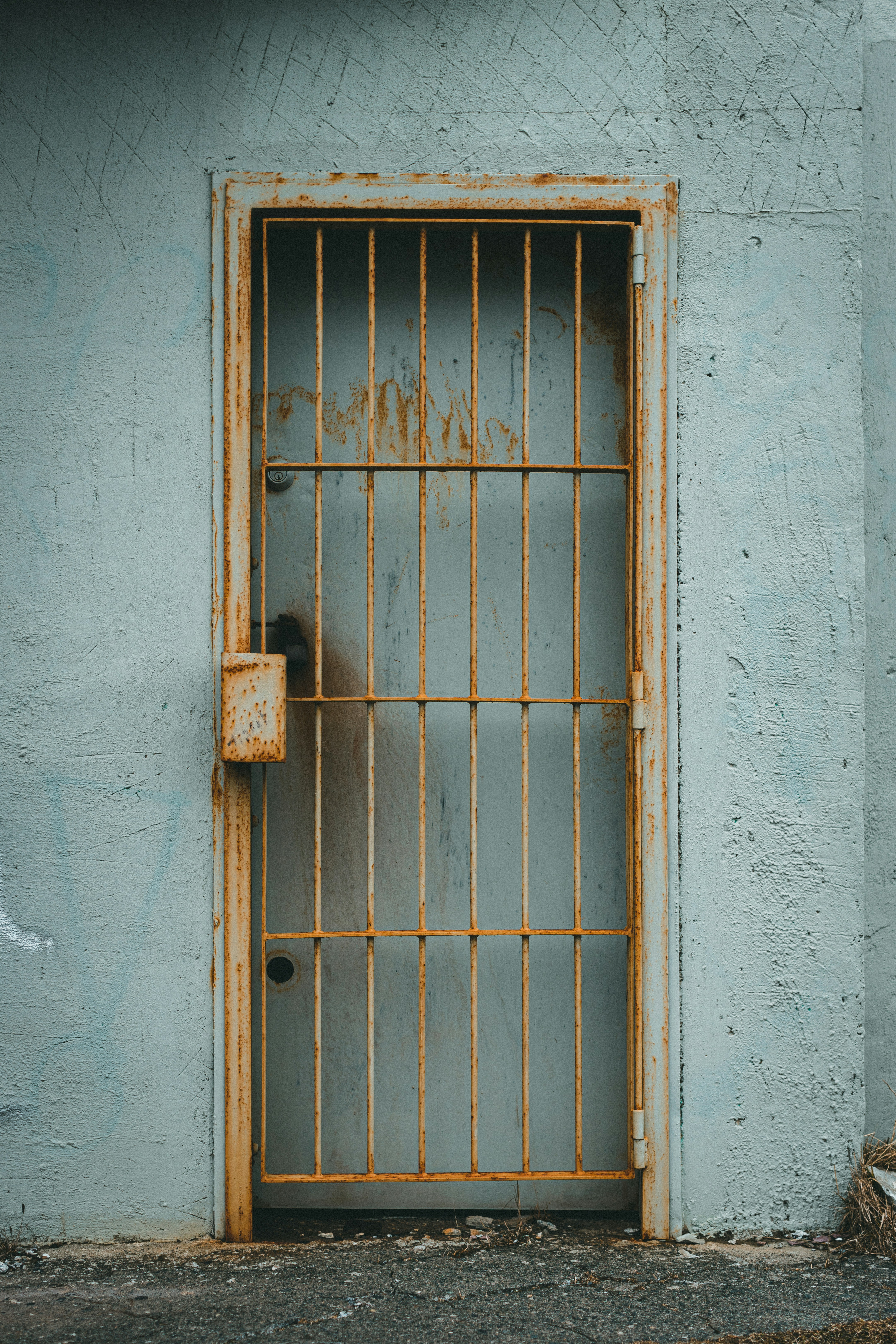 An old jail cell door with bars on it photo – Free Grey Image on Unsplash
