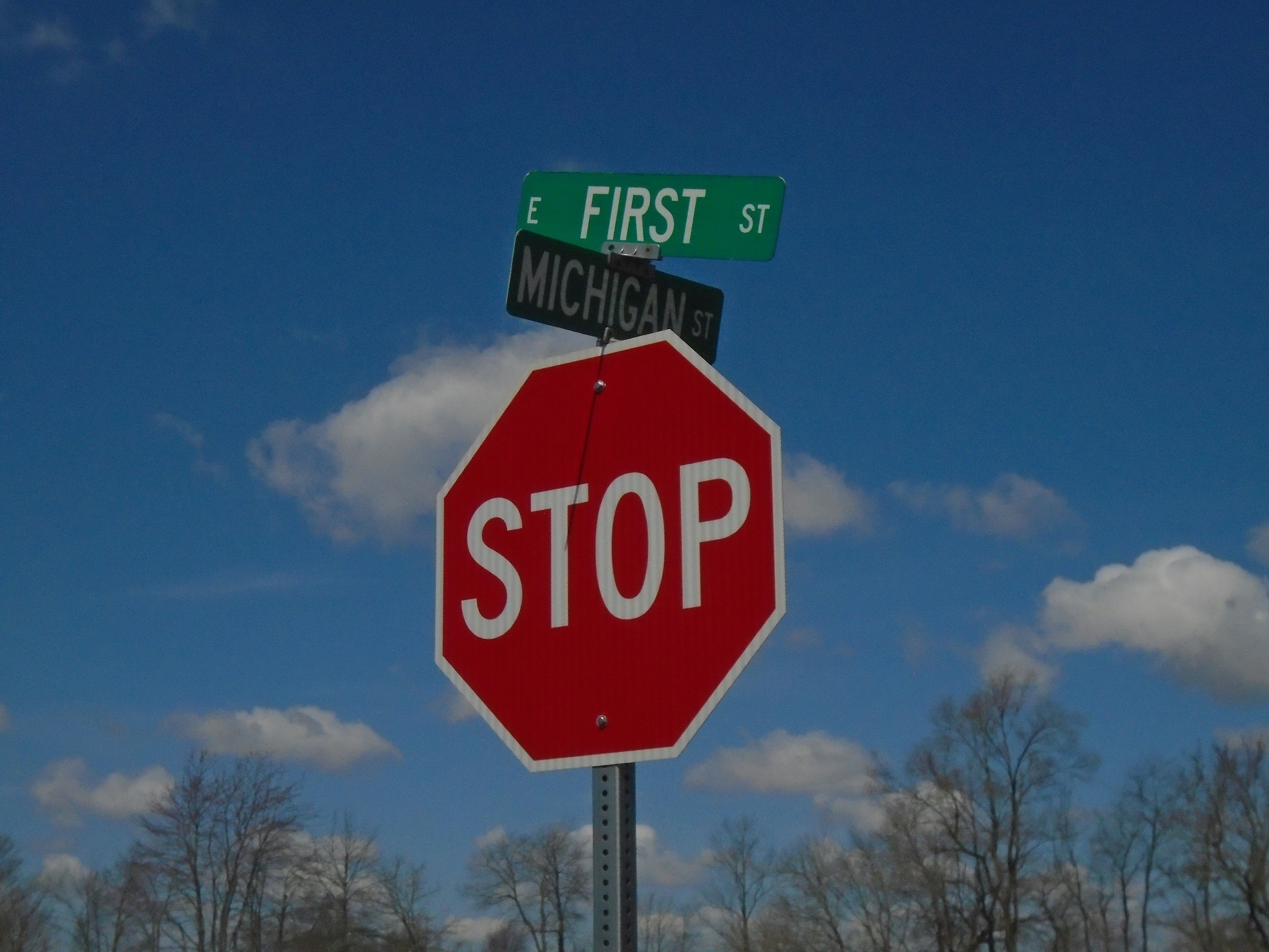 A stop sign with two street signs on top of it photo – Free Brown Image ...