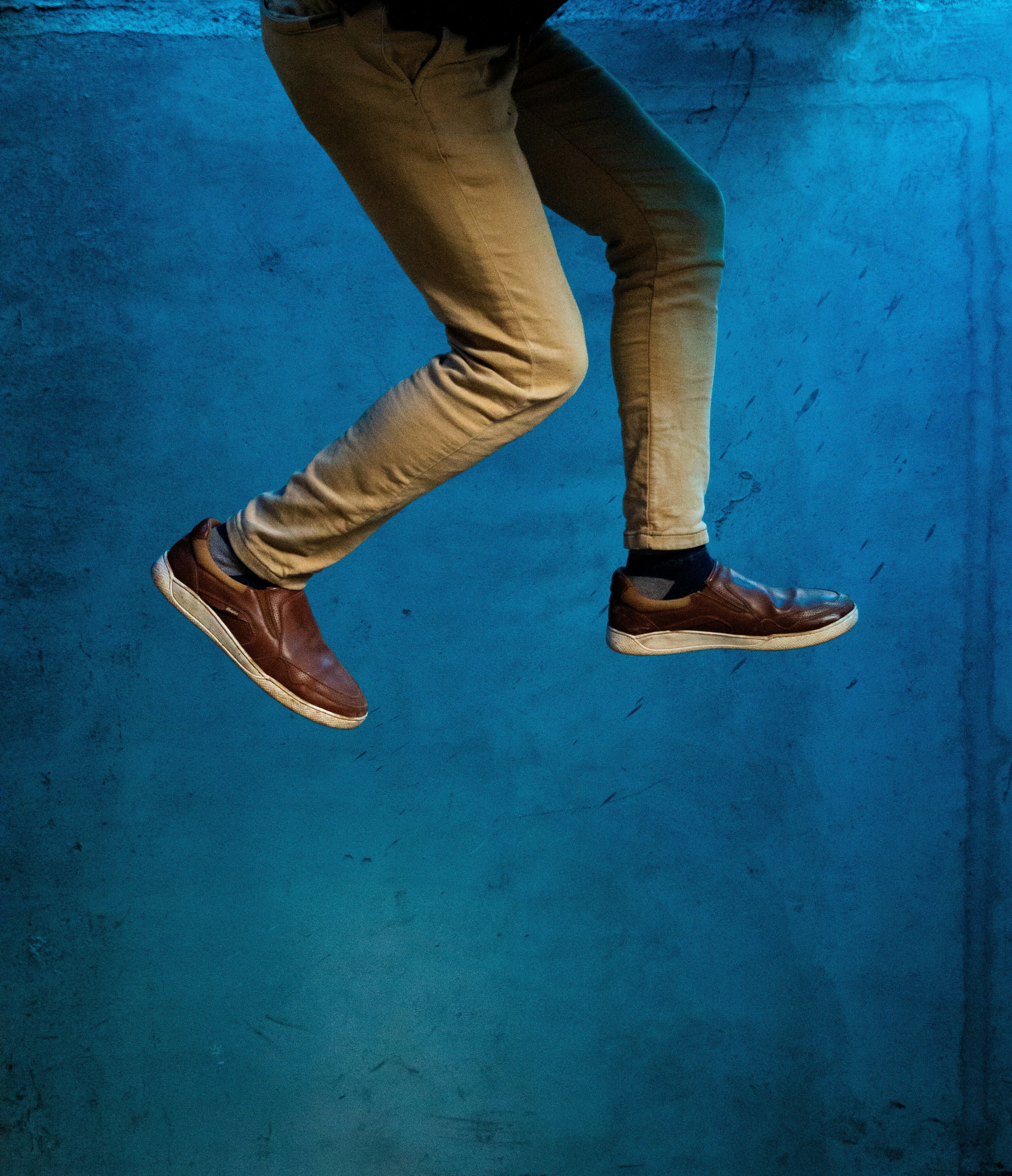 Cobalt Leap: Brown Sneakers in Free Fall