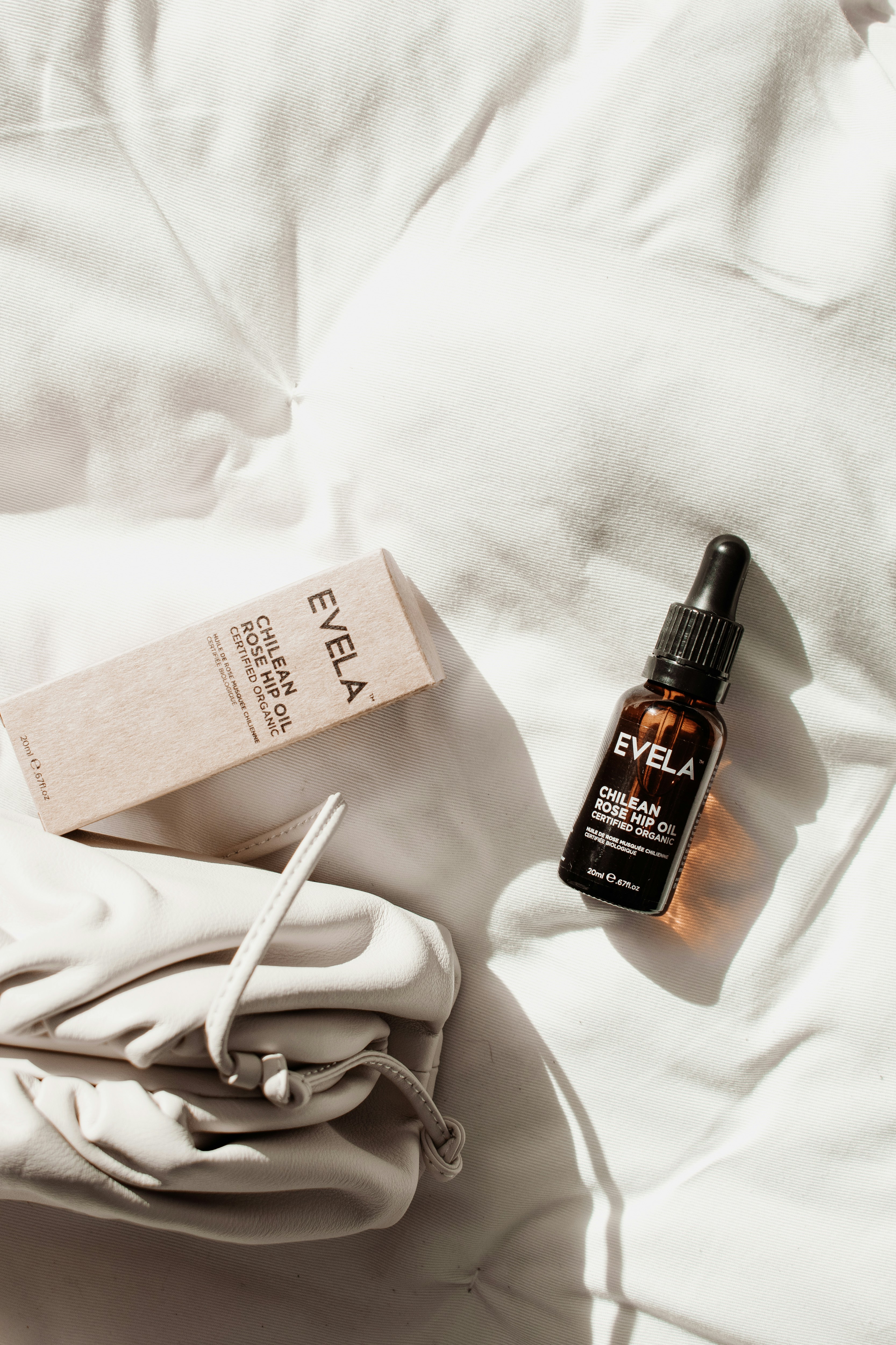 A bottle of essential oils sitting on a bed photo – Free Brown Image on ...