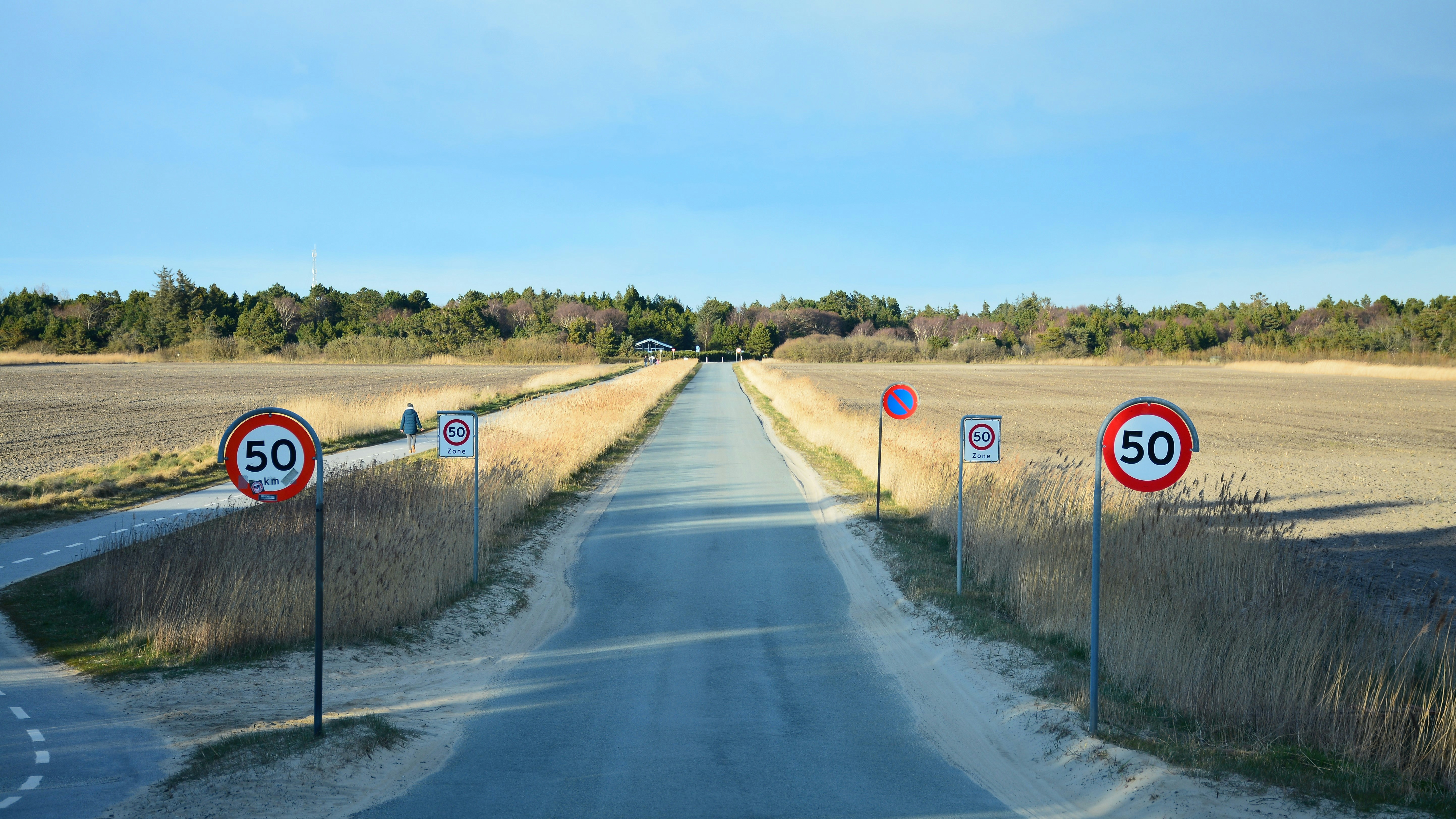 A road with a number of speed limit signs on it photo – Free Road Image ...