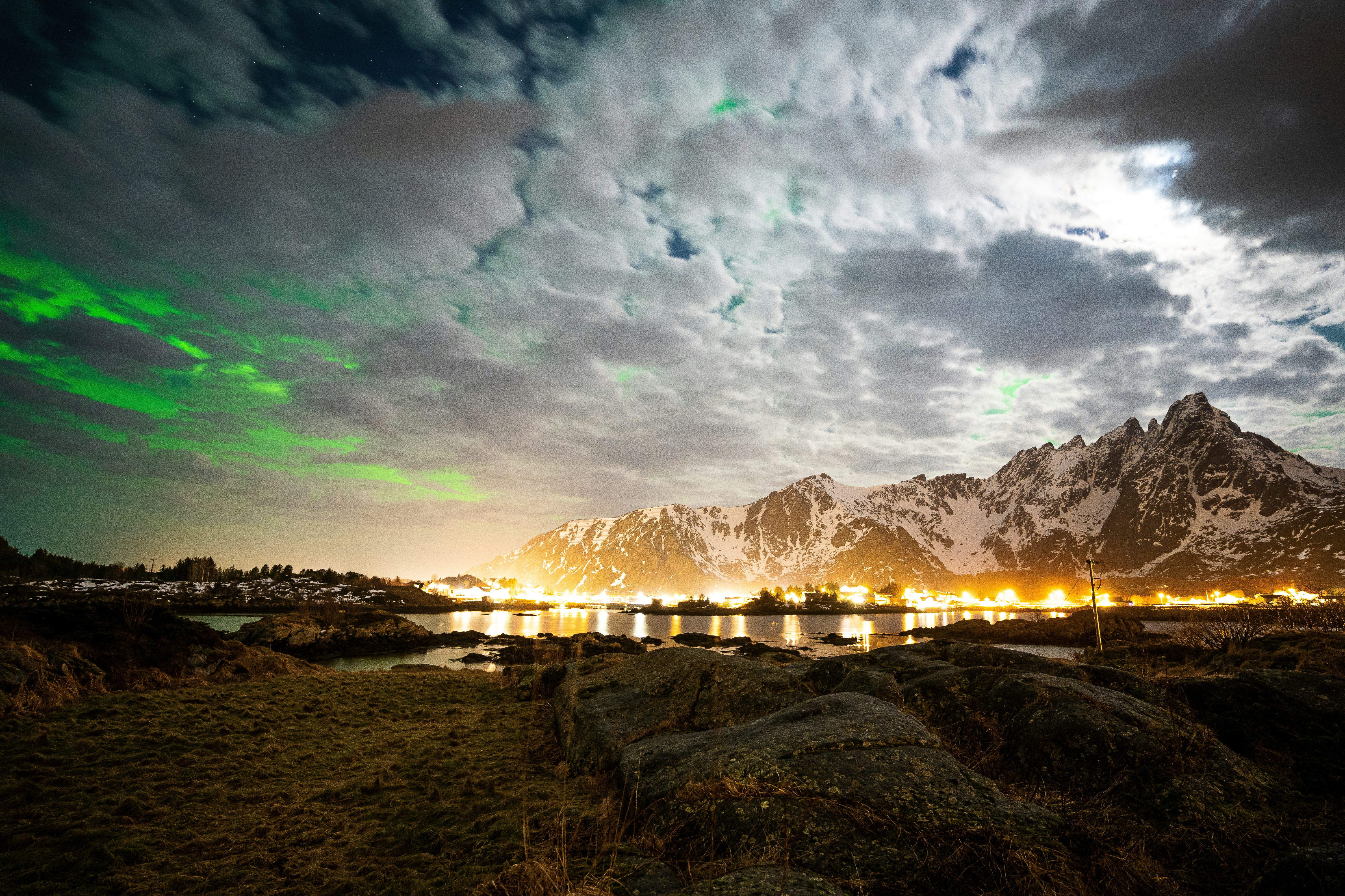Emerald Aurora Over Snowbound Peaks by a Luminous Inlet