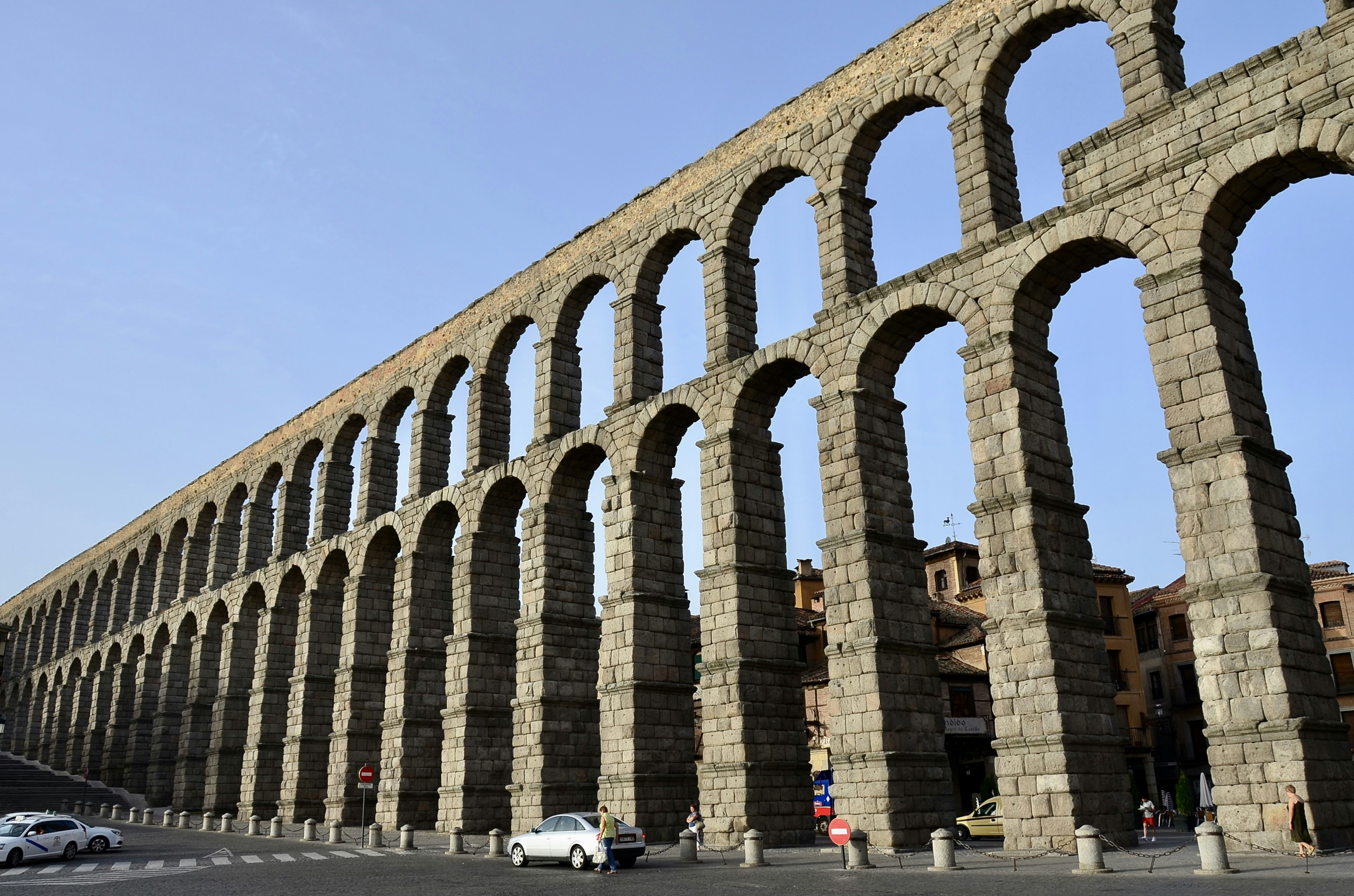 A large stone structure with arches on the side of it photo – Free ...