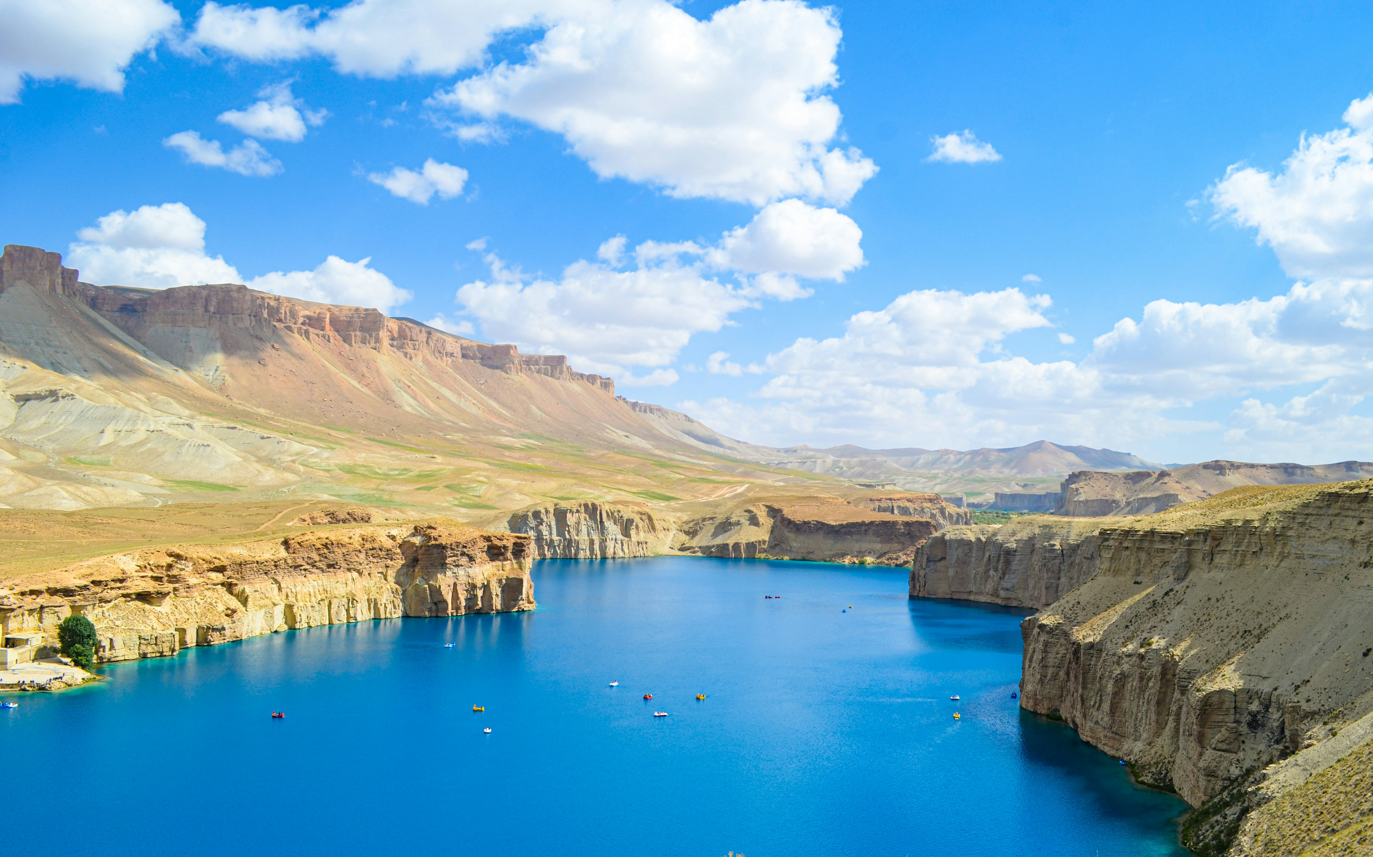A large body of water surrounded by mountains photo – Free Bamyan Image ...