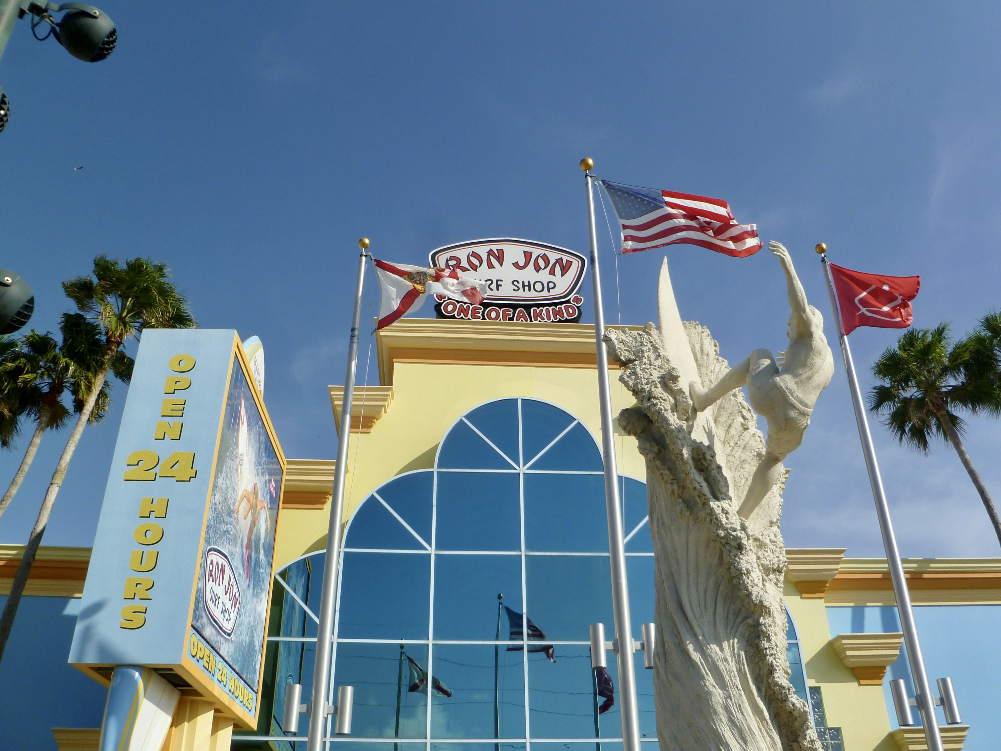 Sunlit Façade of Iron Jon’s Hobby Shop: A Colorful Coastal Landmark