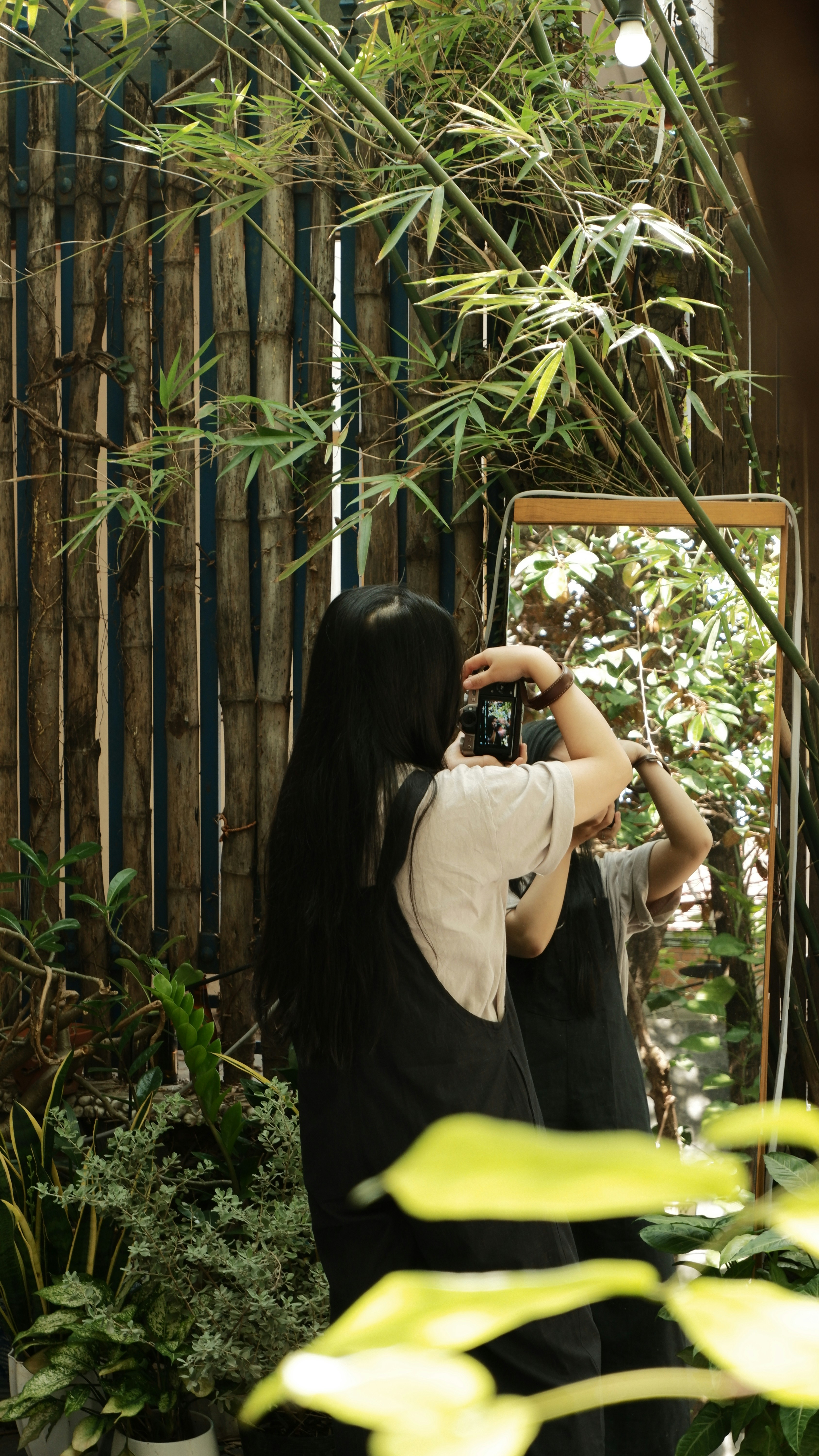 a woman taking a picture of herself in a mirror