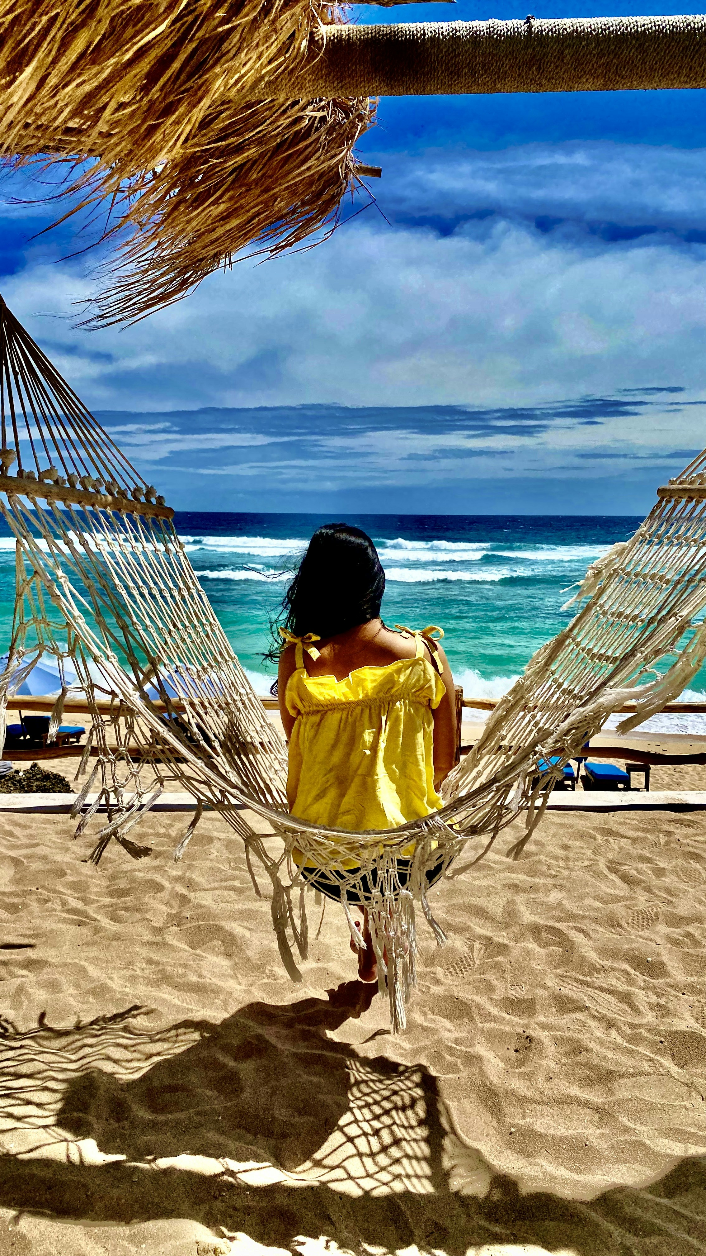 A woman sitting in a hammock on the beach photo – Free Bali Image on ...