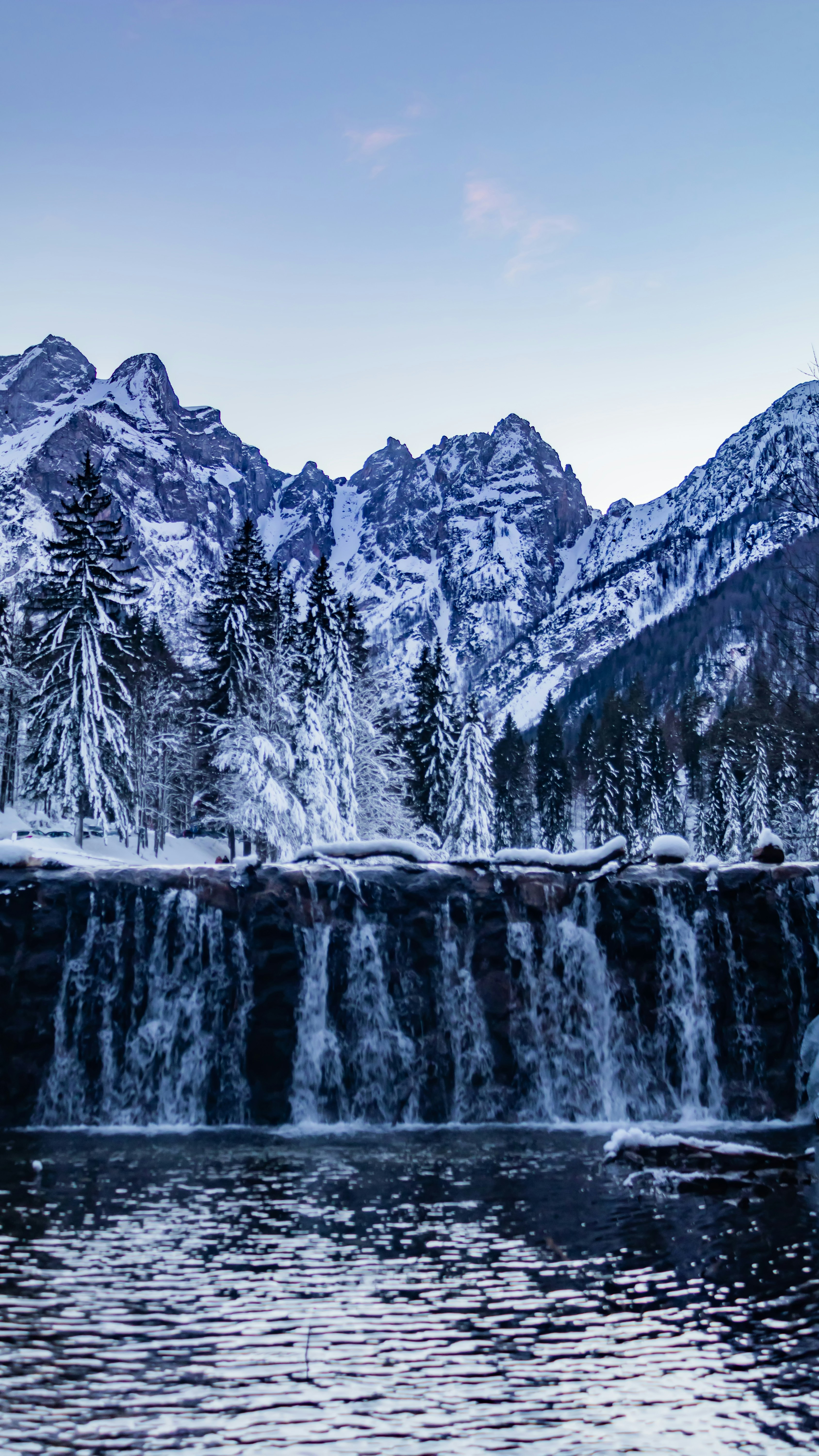 Blue Hour Cascade: Snow-Capped Peaks Framing a Winter Waterfall