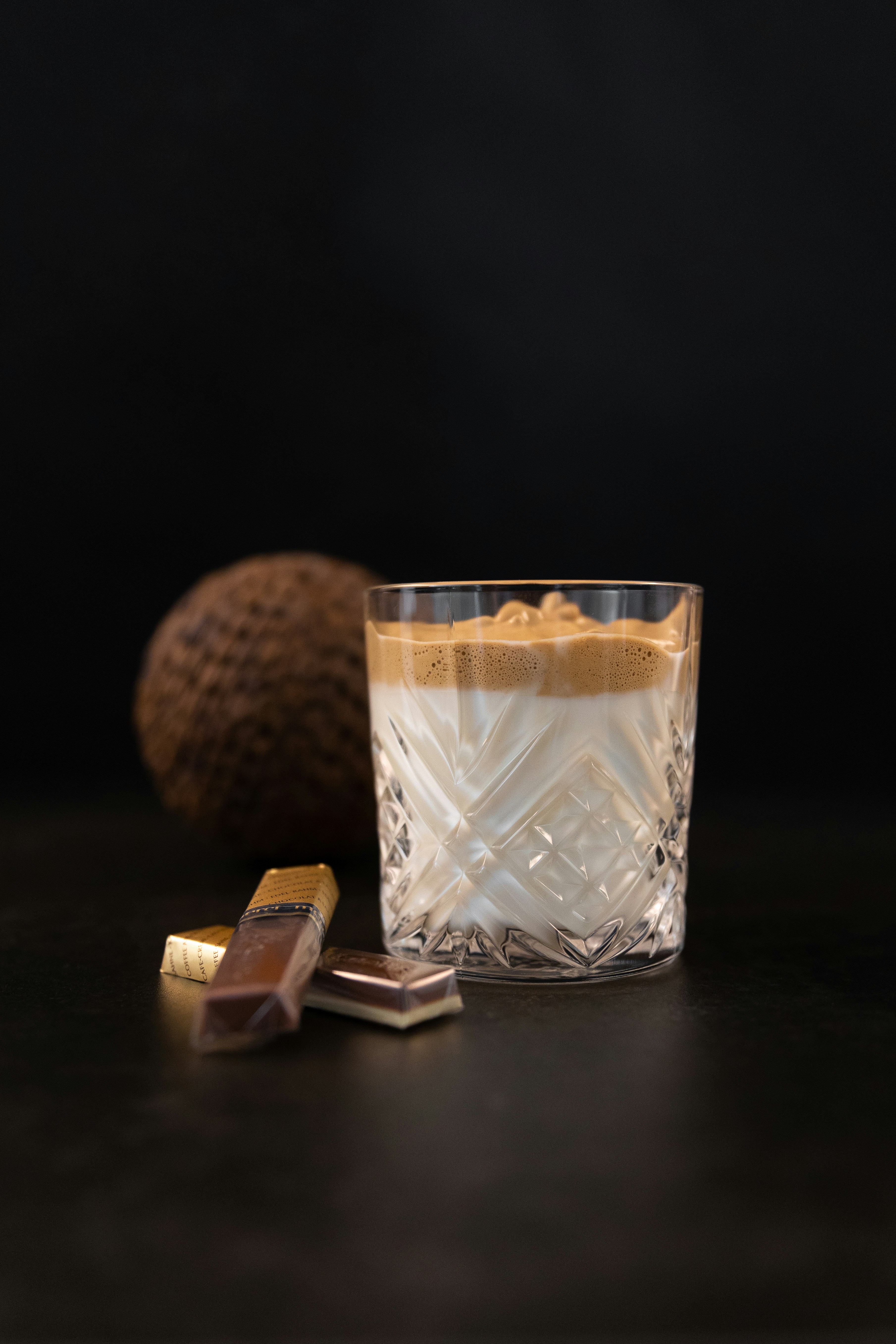 Crema on Crystal: Latte in a Faceted Glass with Chocolate Fragments