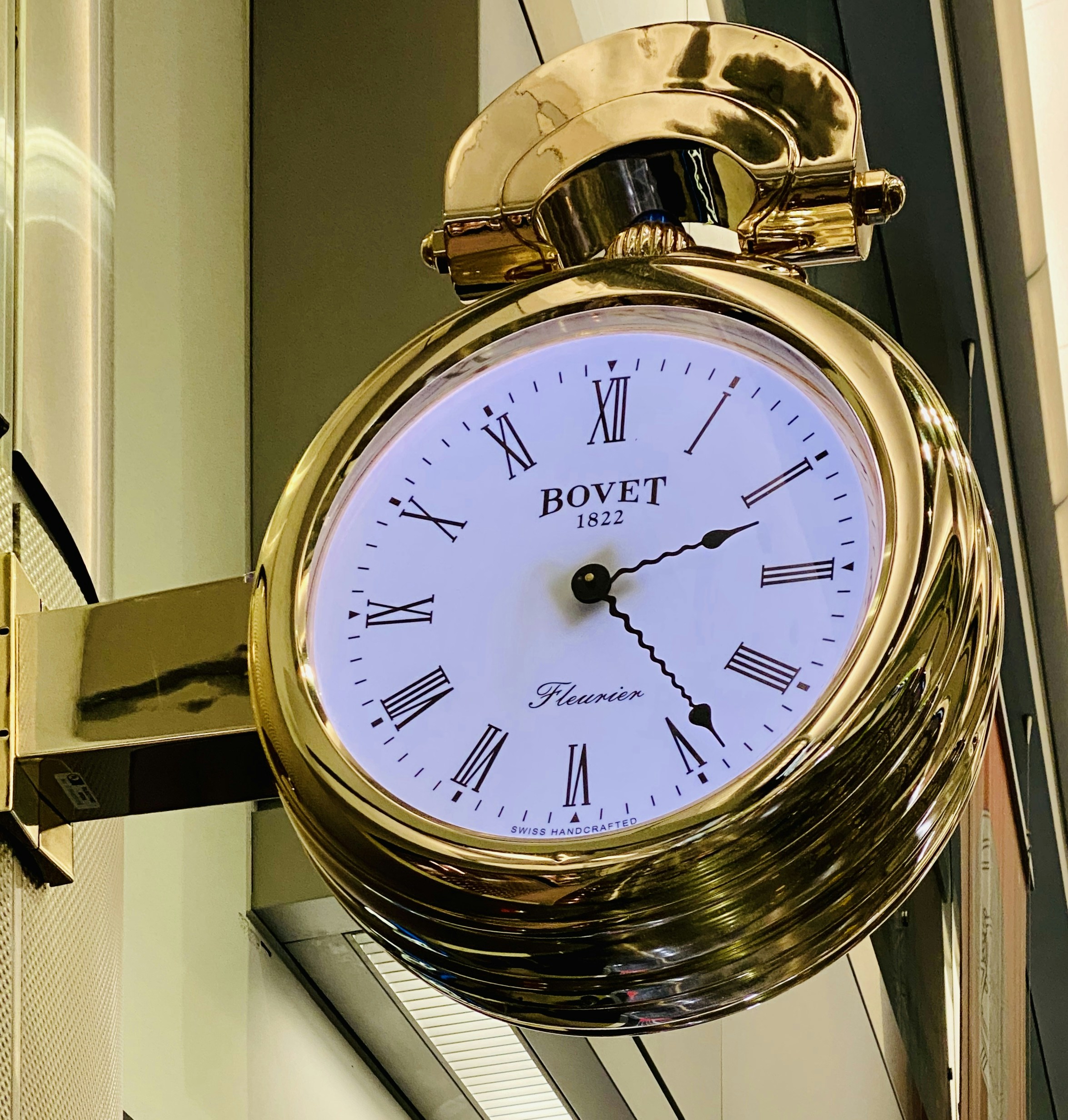 Bovet in Gold: A Pocket Watch Framed by Chrome and Warm Reflections