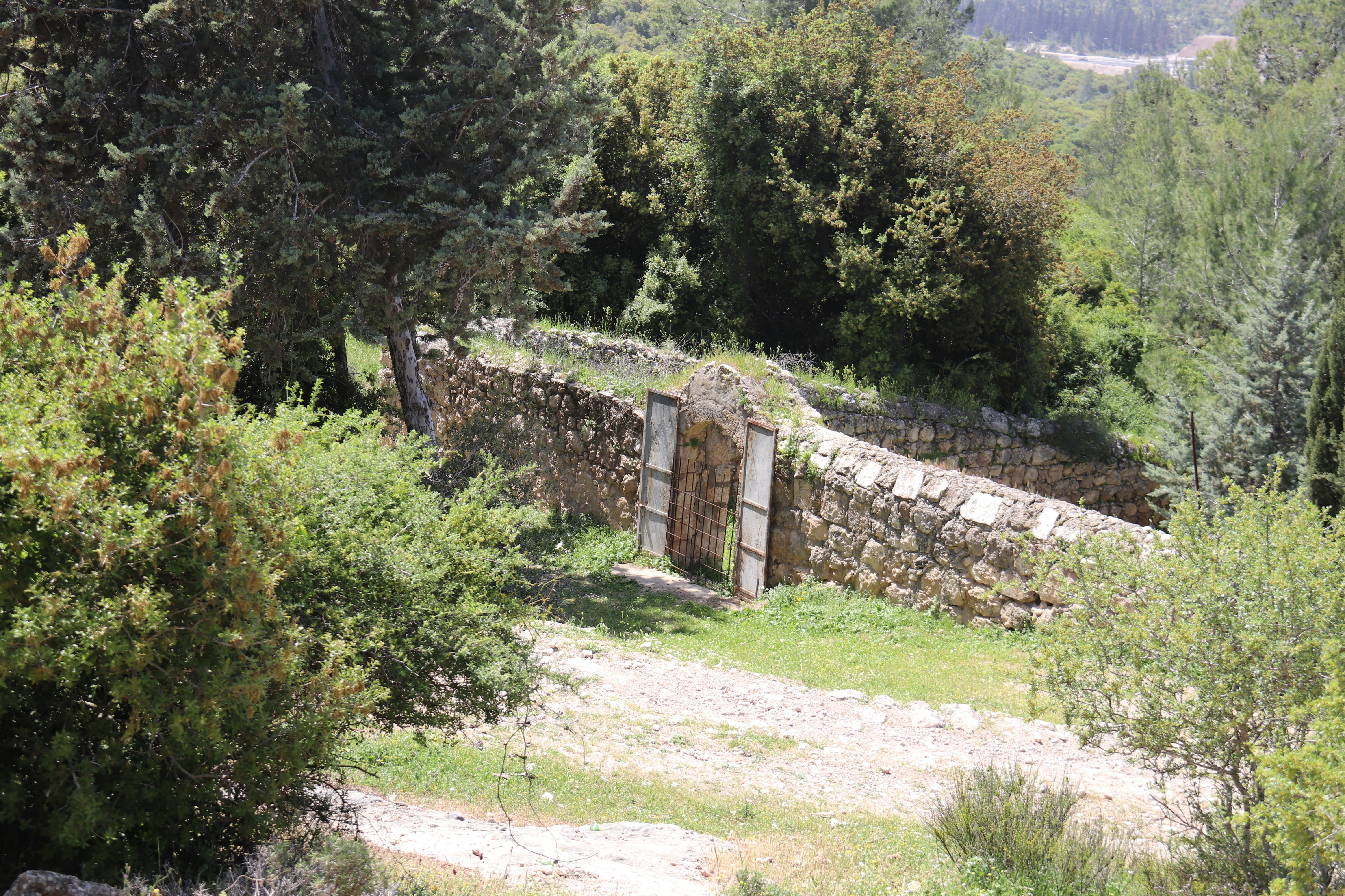A stone wall and gate in a wooded area photo – Free Beit jimal Image on ...