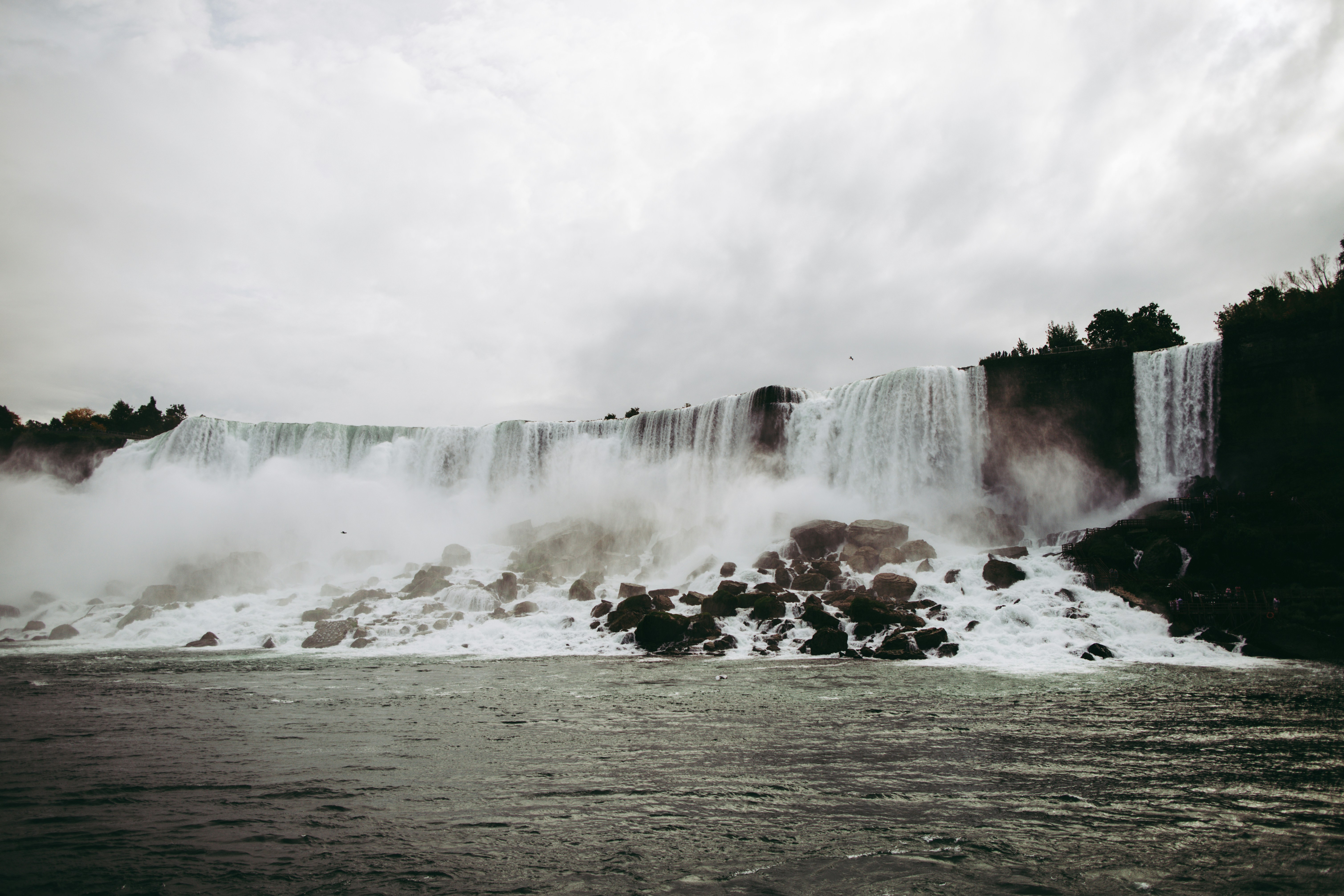 A large waterfall with water coming out of it photo – Free Grey Image ...