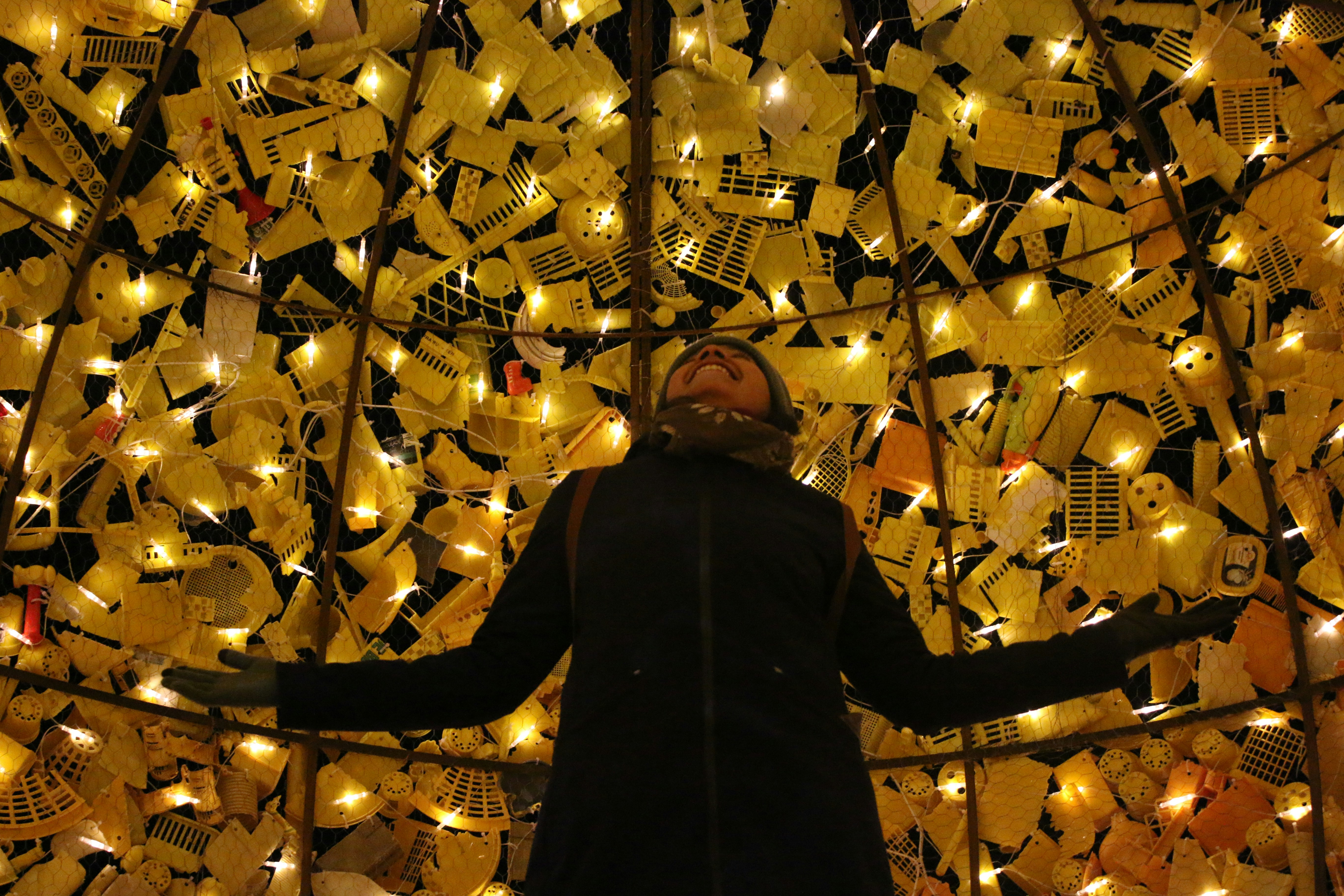 a man standing in front of a wall covered in lights