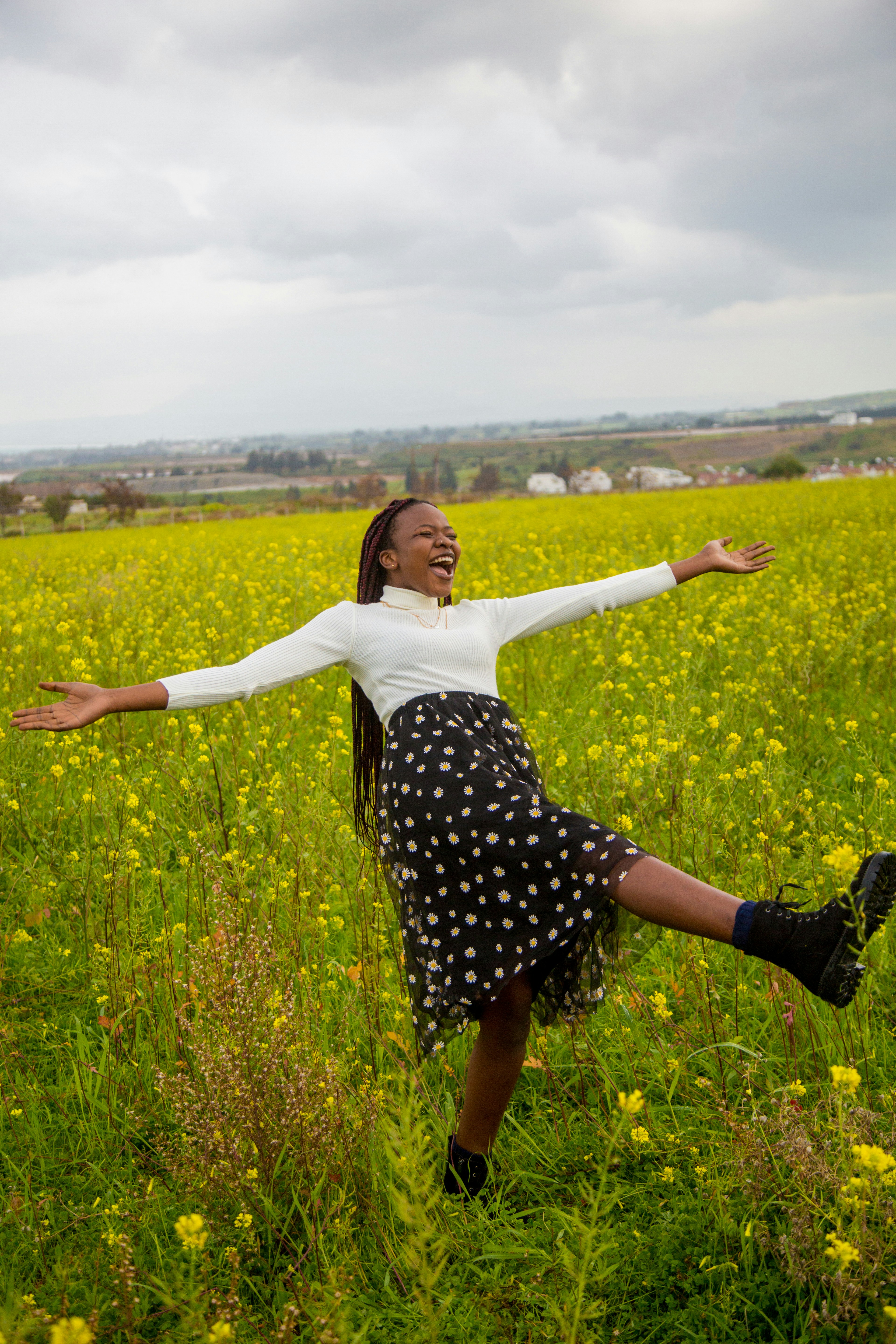 Arms Wide in a Canola Field: A Joyful Leap