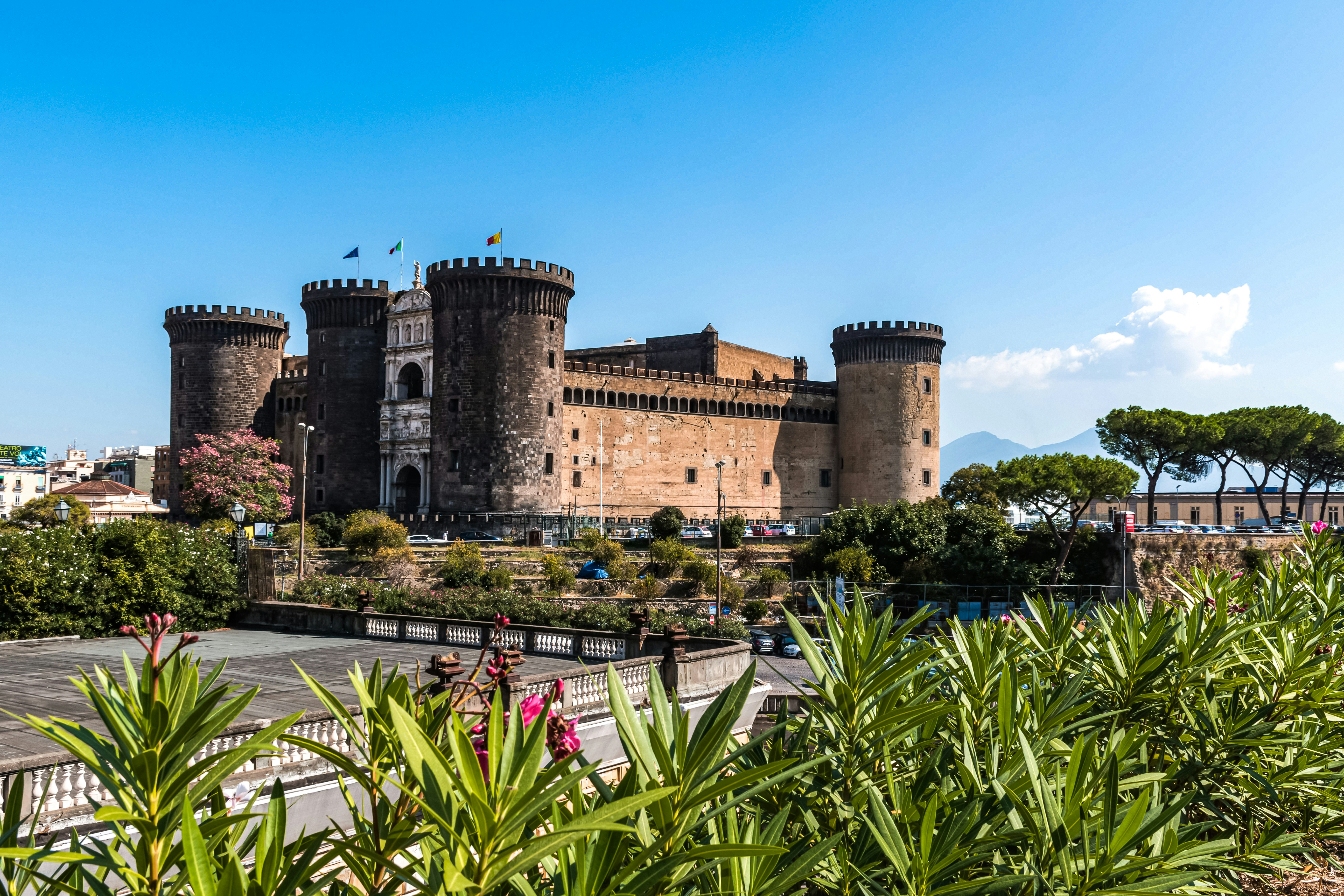 A large castle with a clock tower on top of it photo – Free Napoli ...