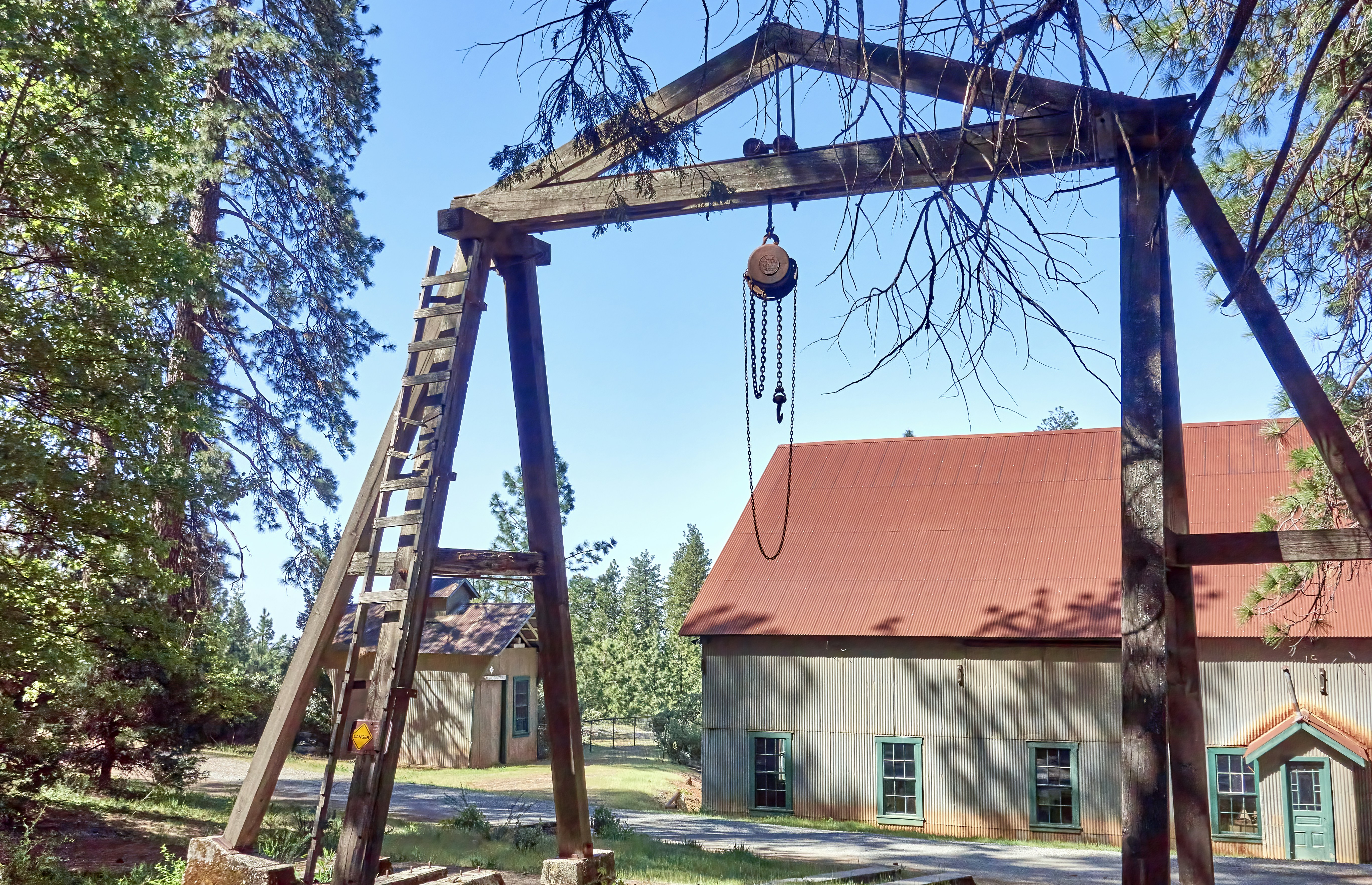 Block and tackle | a wooden swing set in front of a building