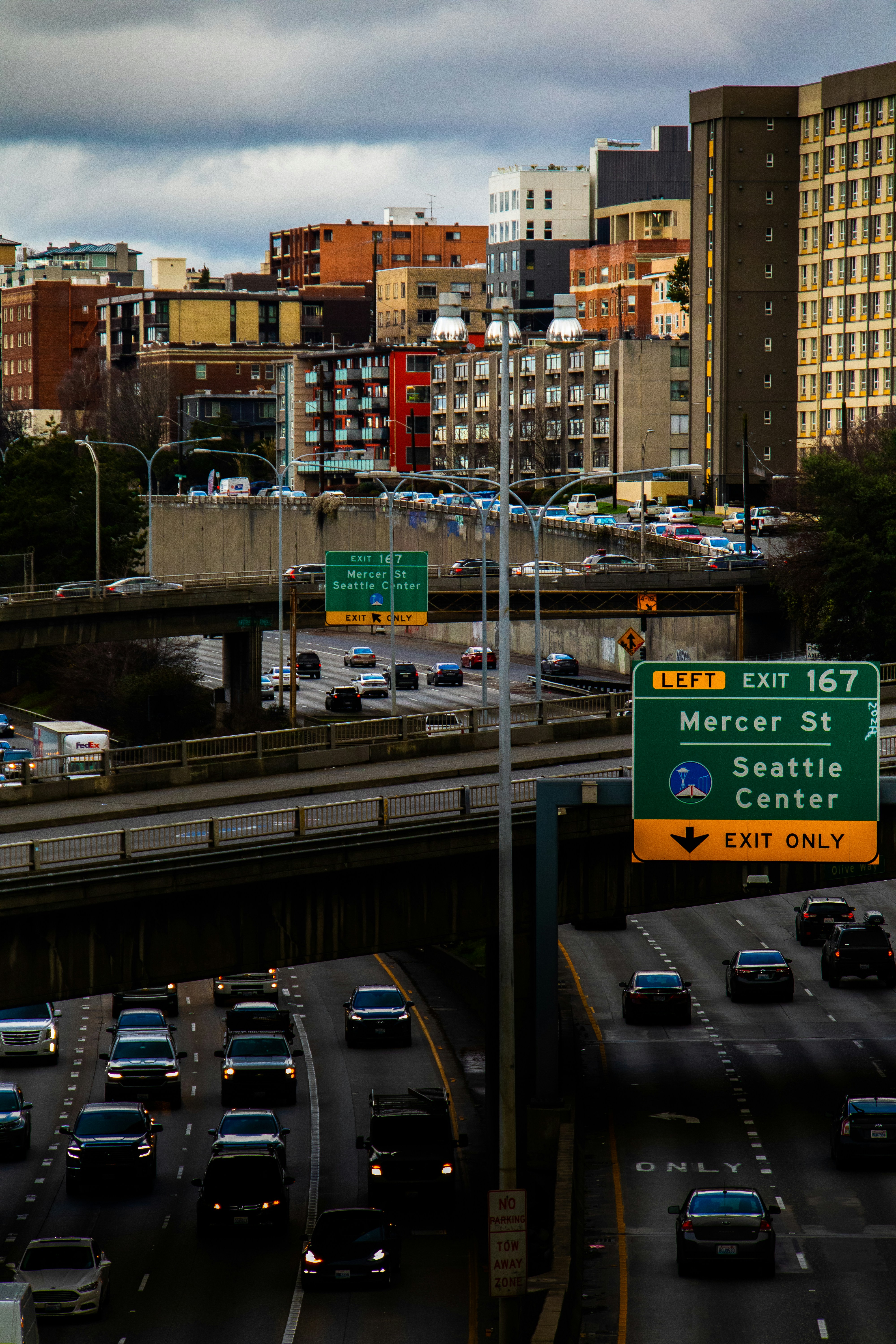 A freeway filled with lots of traffic next to tall buildings photo ...