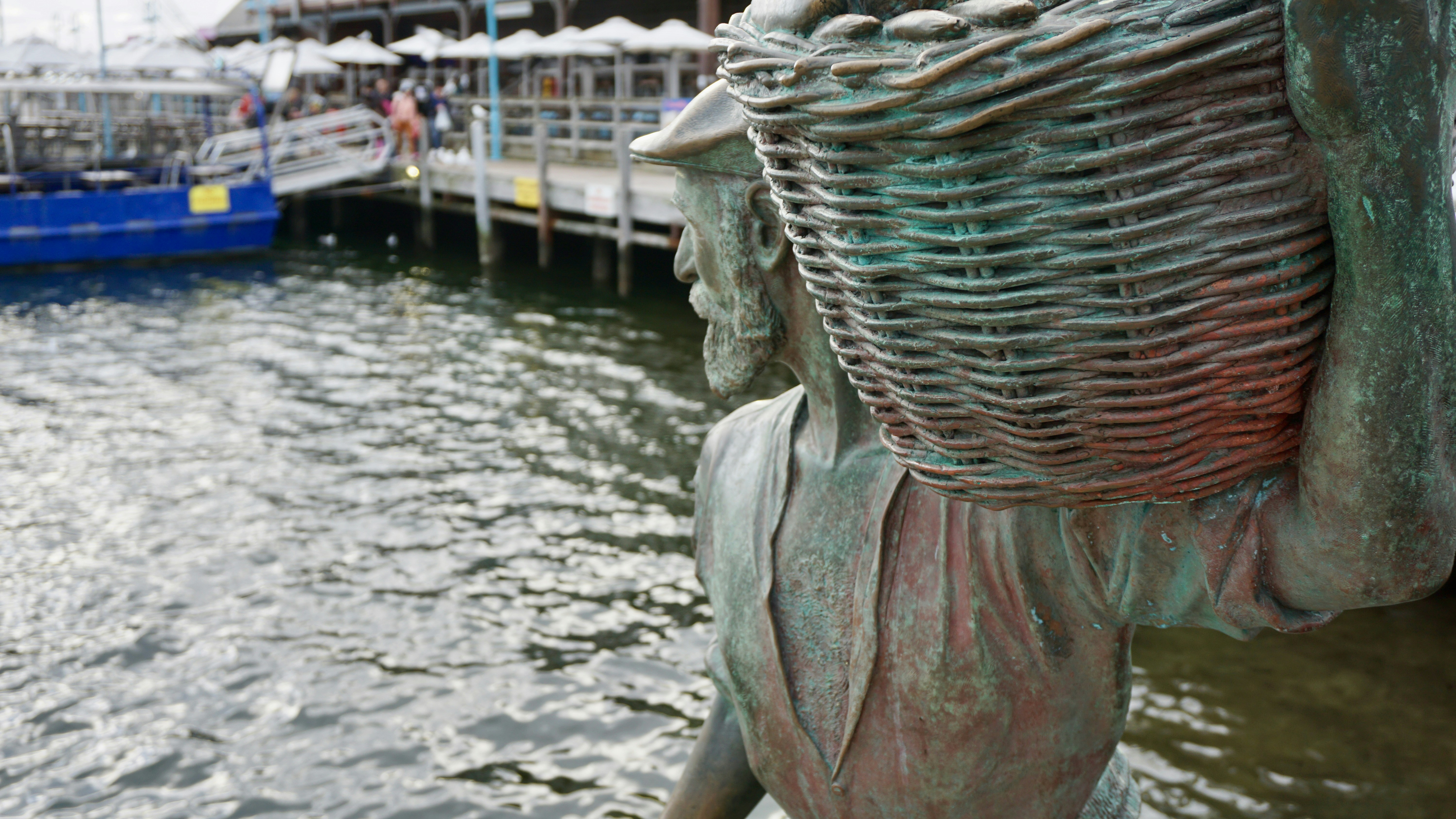 A statue of a woman looking out over a body of water photo – Free ...