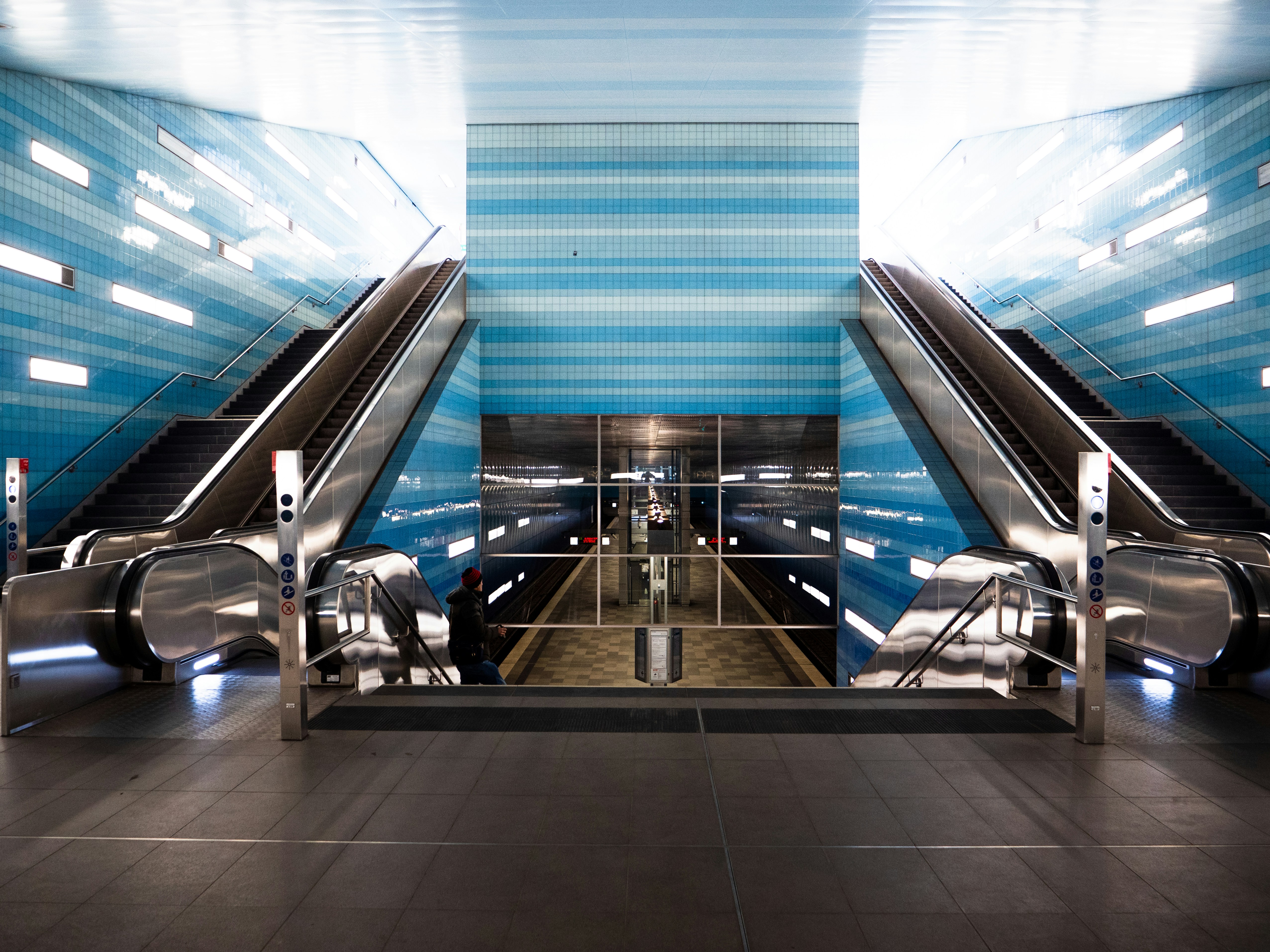 Symmetrical Suburban Exit: Blue-tiled Subway Station at Dusk