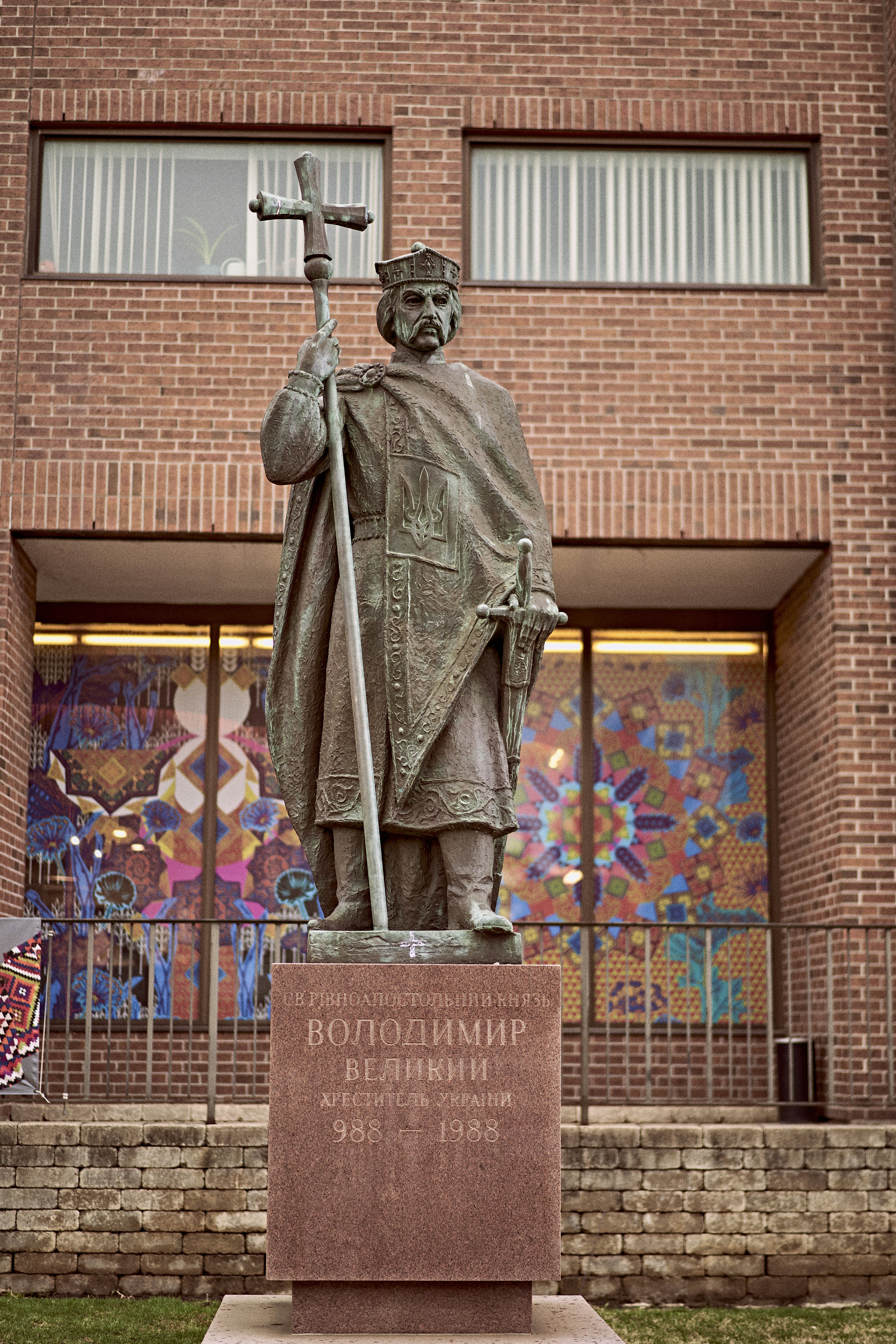 Volodymyr Veliky Stands Before a Mosaic-Backed Brick Facade